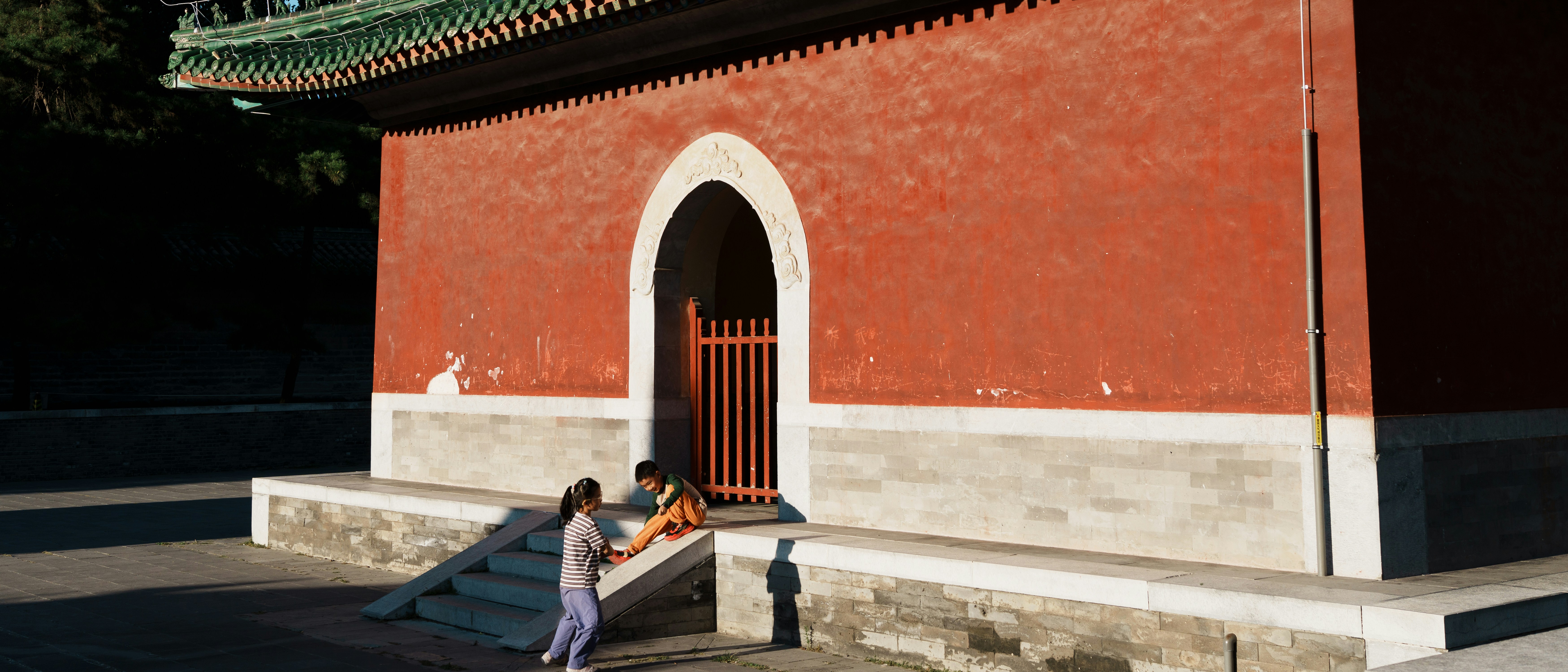 Red Gate, Quiet Exchange: A Moment at the Temple Courtyard