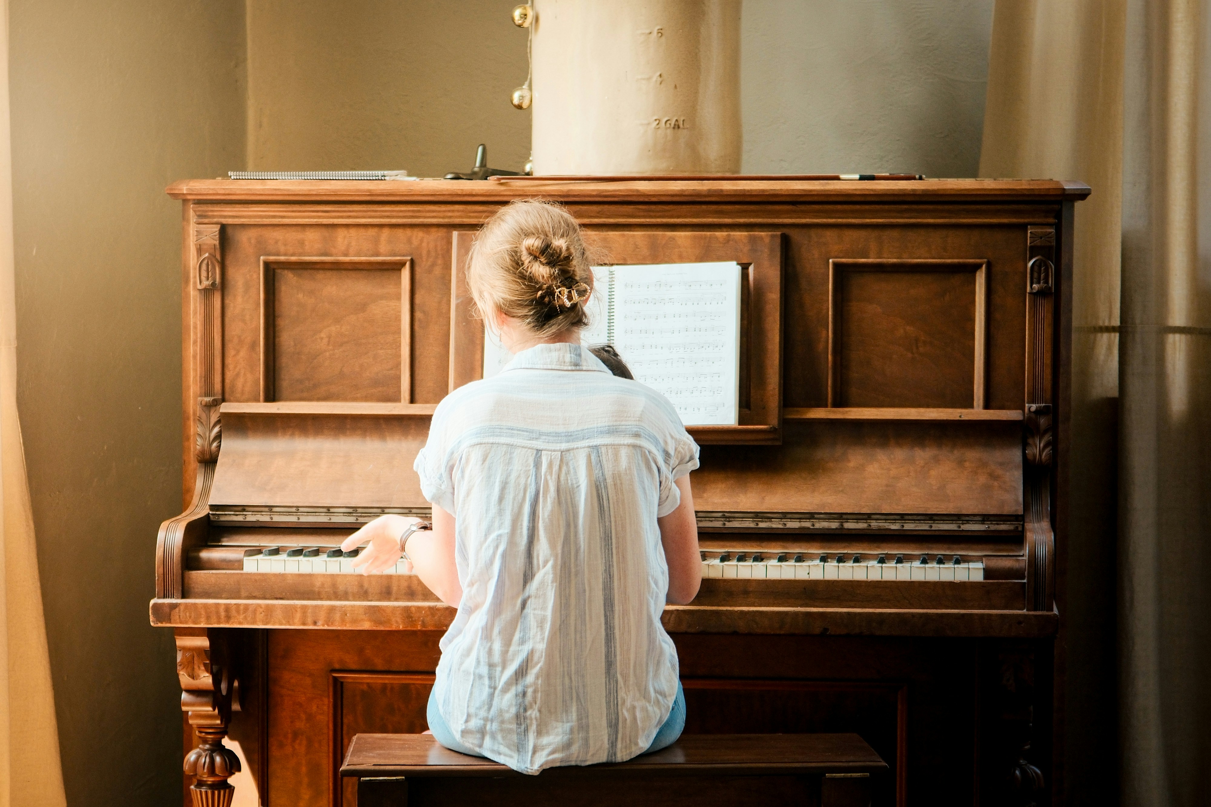Back to the Keys: A Quiet Moment at the Wooden Piano
