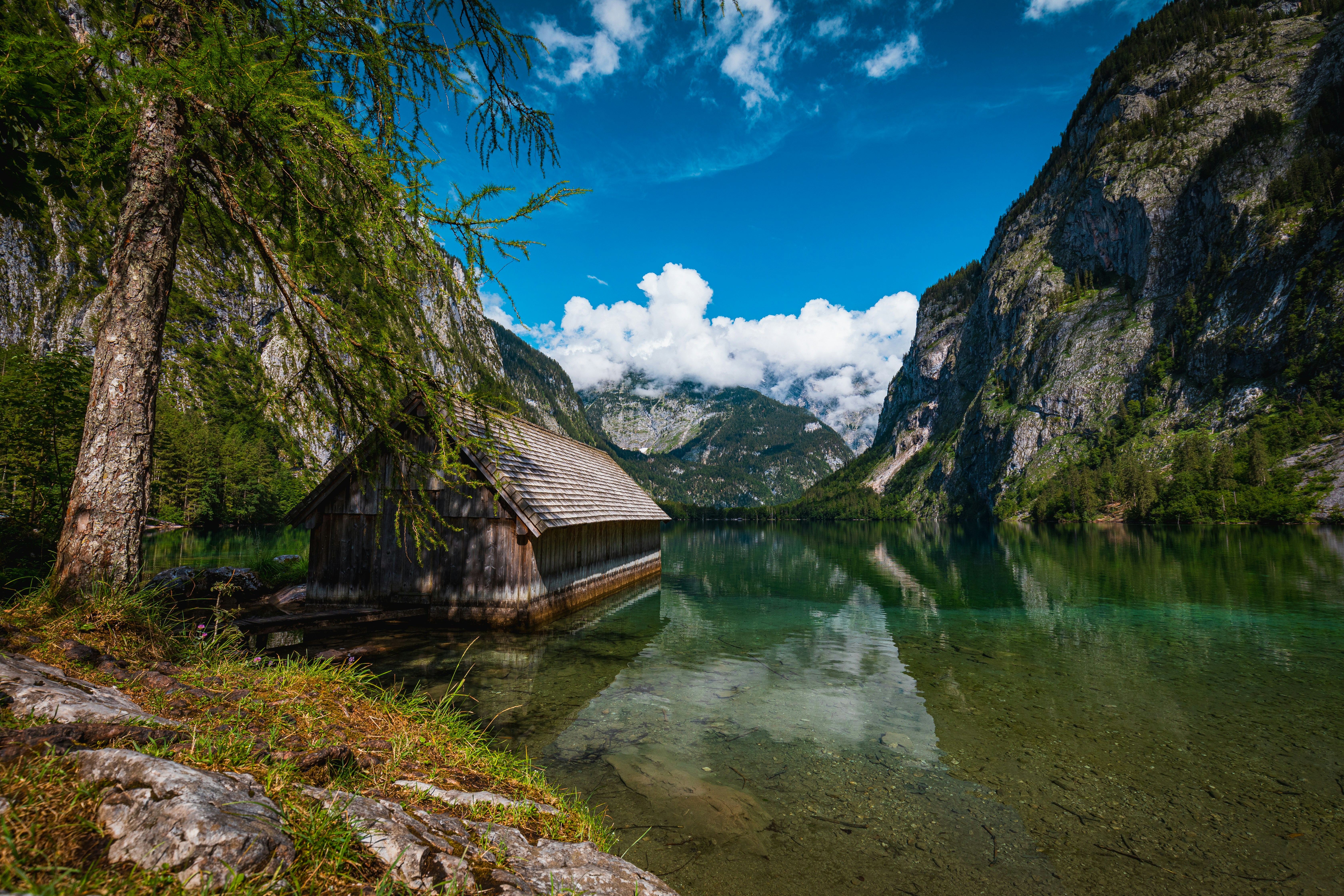 The Azure Boathouse Nestled Between Alpine Reflections