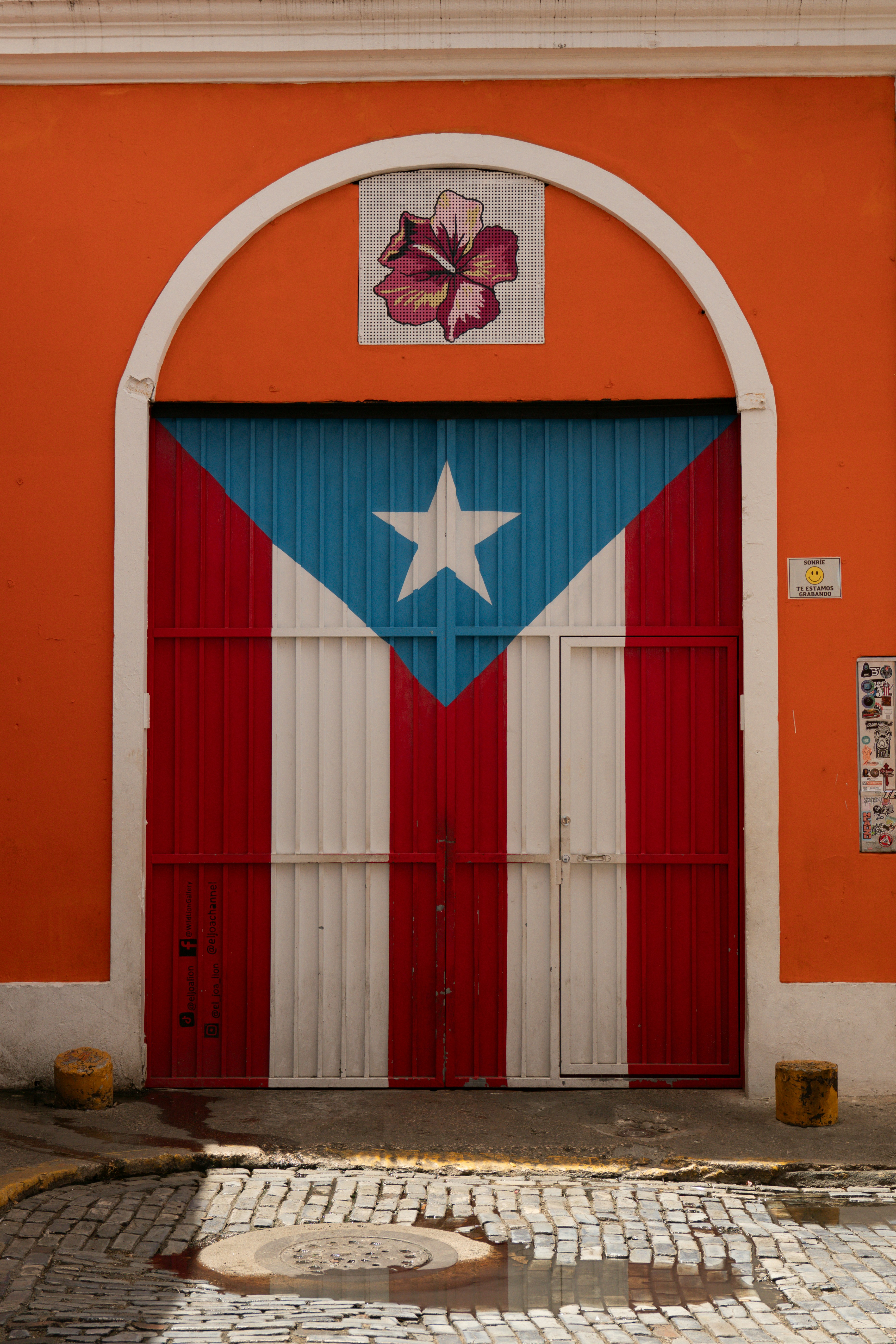 Arched doorway of a Puerto Rican building painted with a flag motif