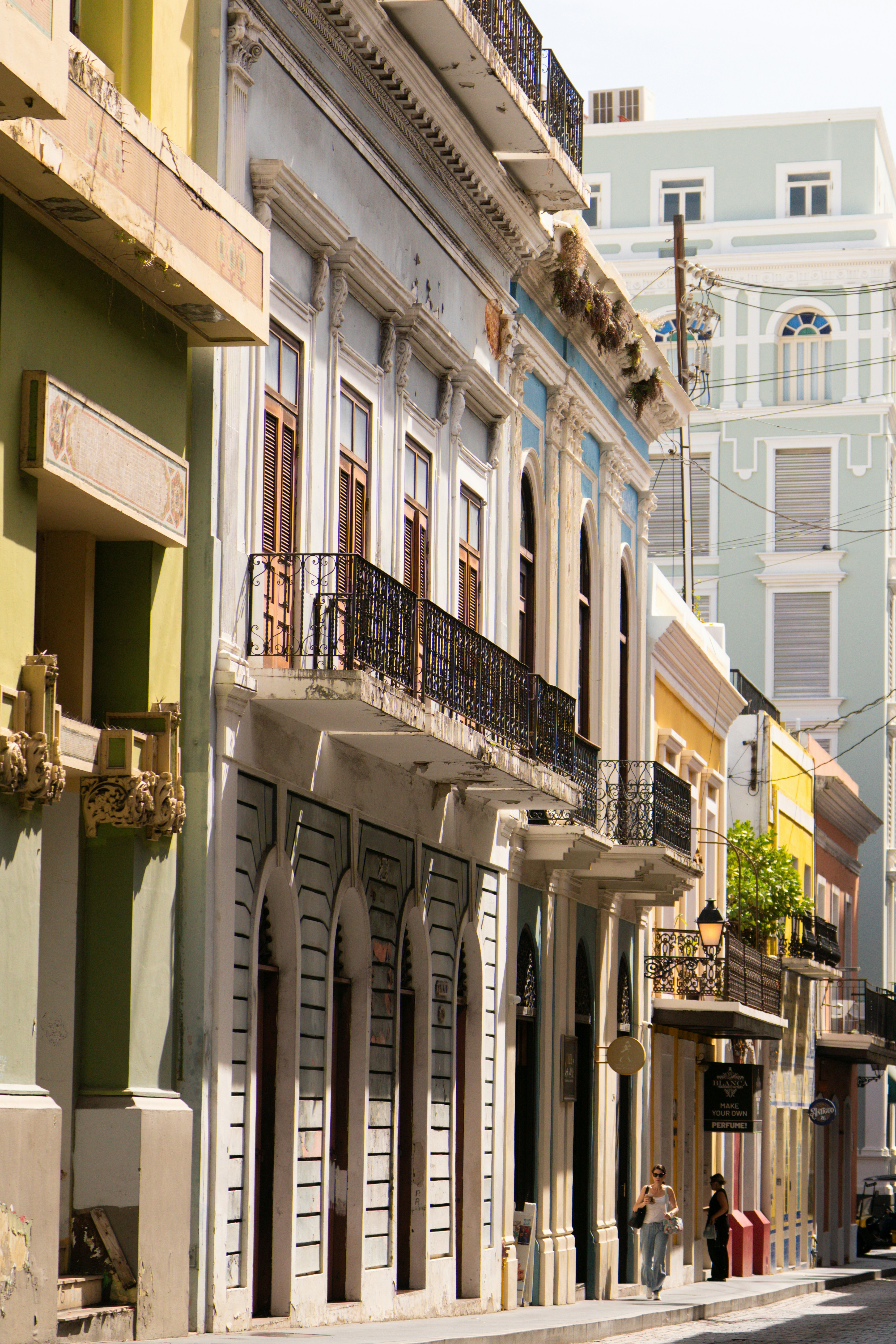 Pastel Veranda Alley: Sunlit Facades and Cast-Iron Balconies