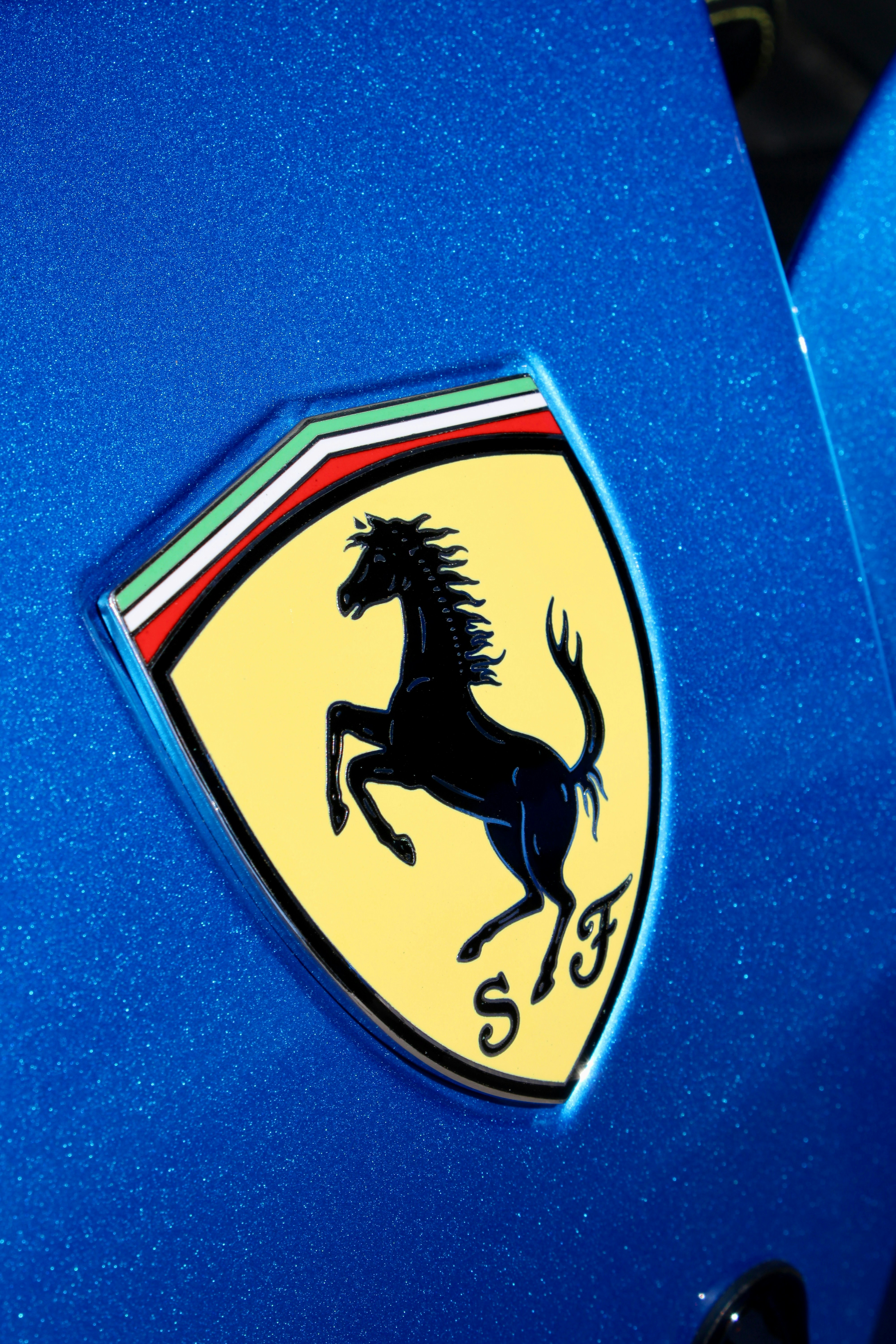Prancing emblem: the Ferrari badge on metallic cobalt