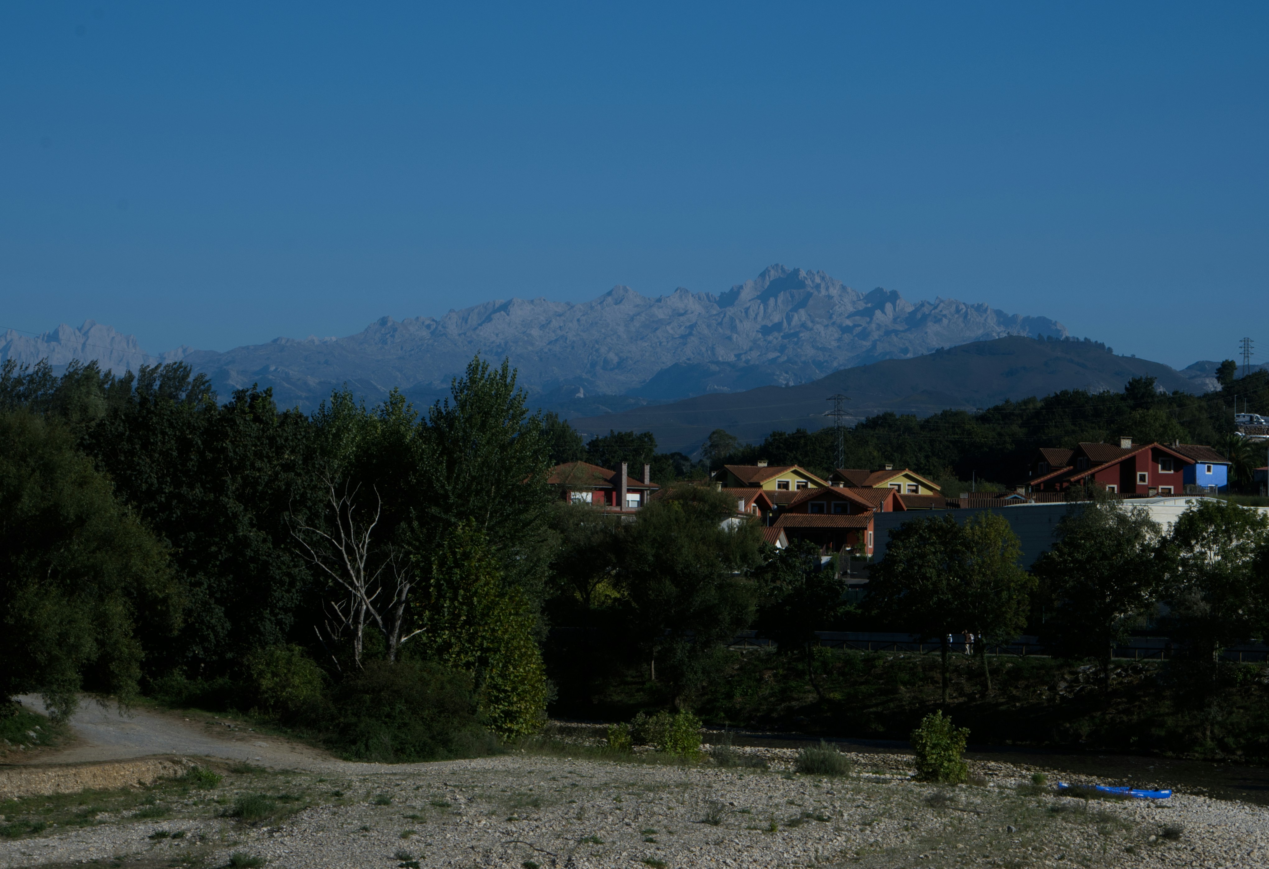 Peaks rising above a river valley village at dusk in Asturias, Spain