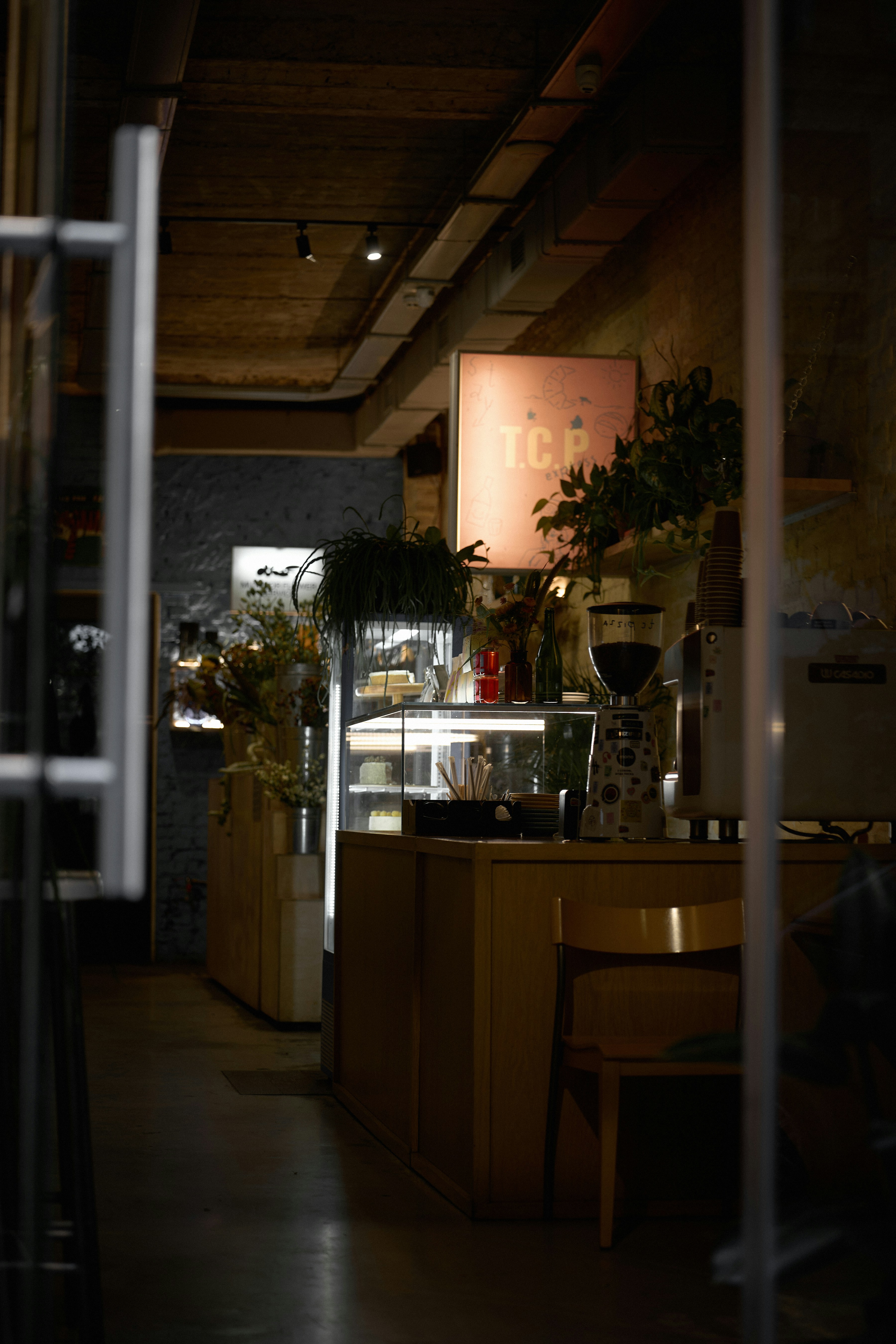 Ambient Café Glow: Quiet Counter in a Dimly Lit Hall