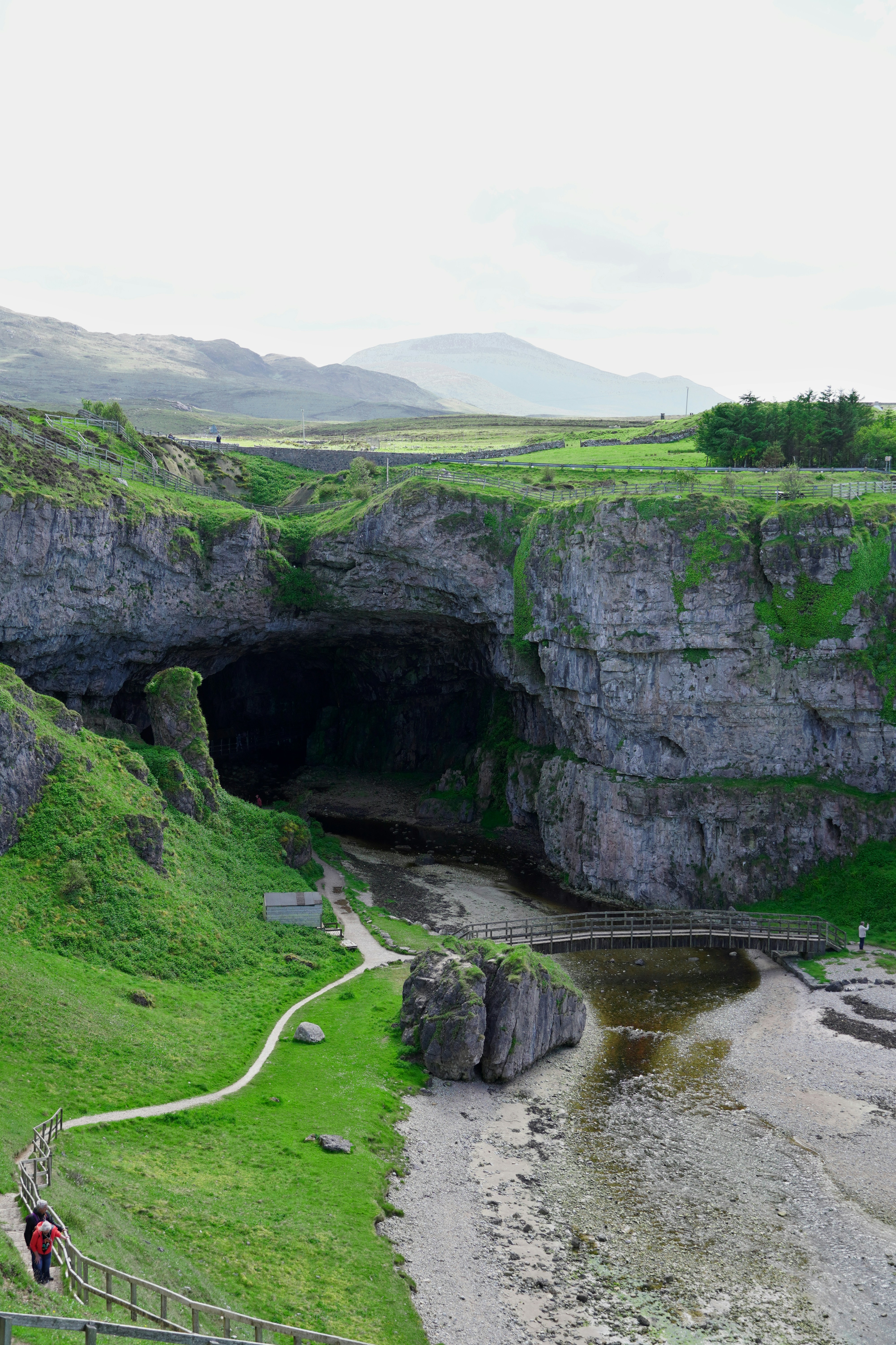 Emerald Gorge Whisper: A Coastal Cliff Scene with Cave Entrance and Path