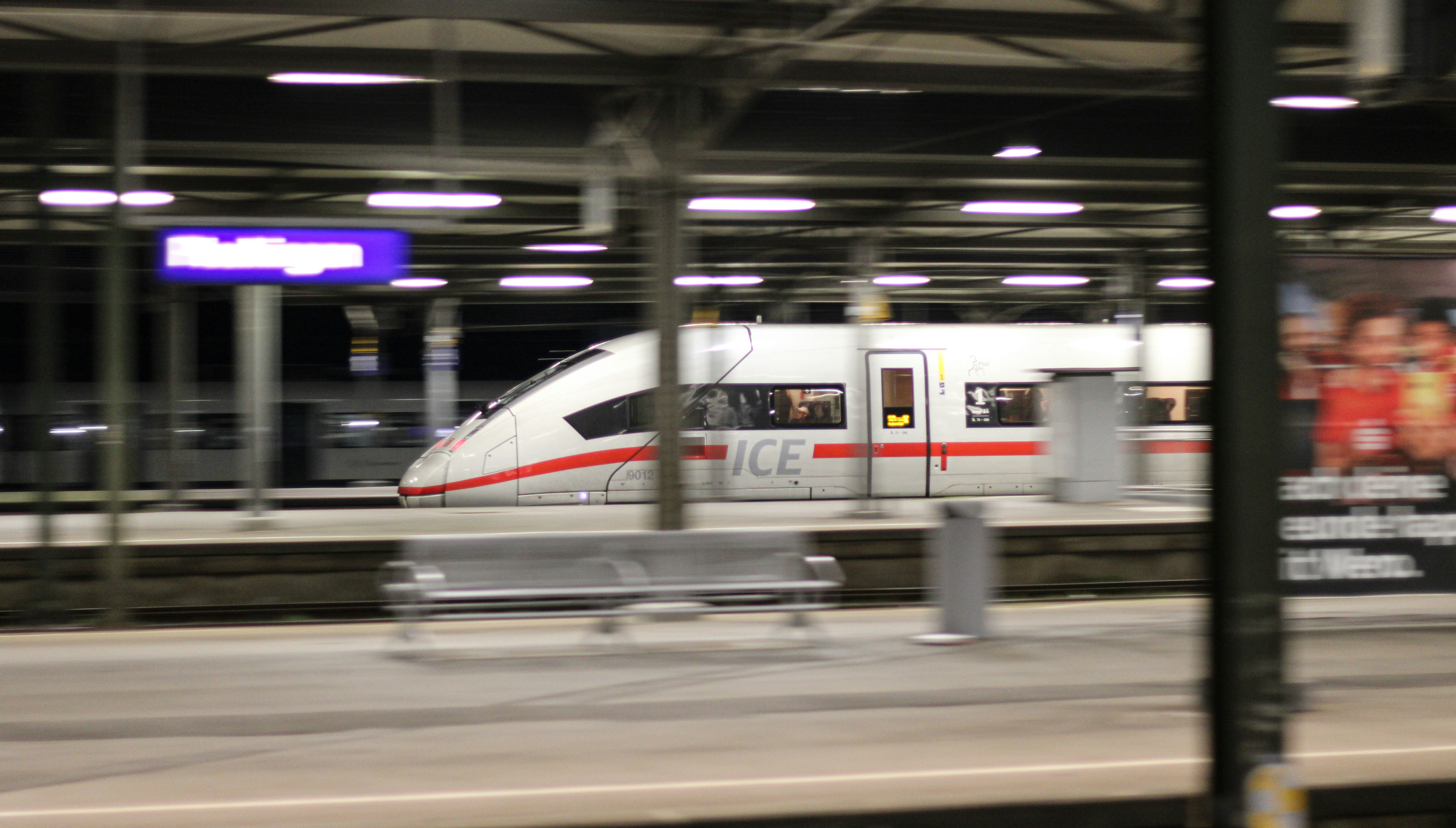 Glide of the ICE: a blurred high-speed train at a quiet station