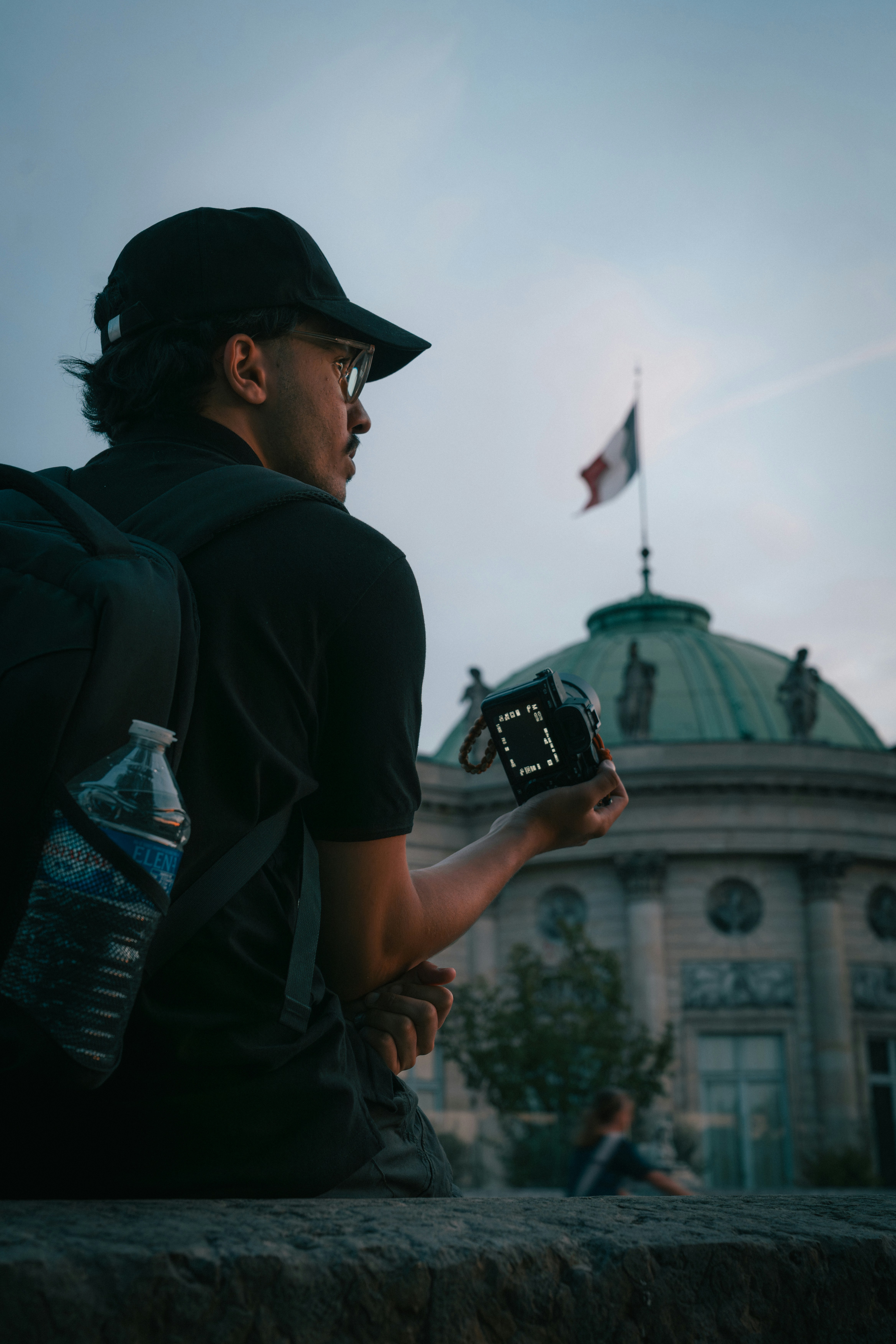 Backlit Portrait of a Street Photographer at a Historic Plaza