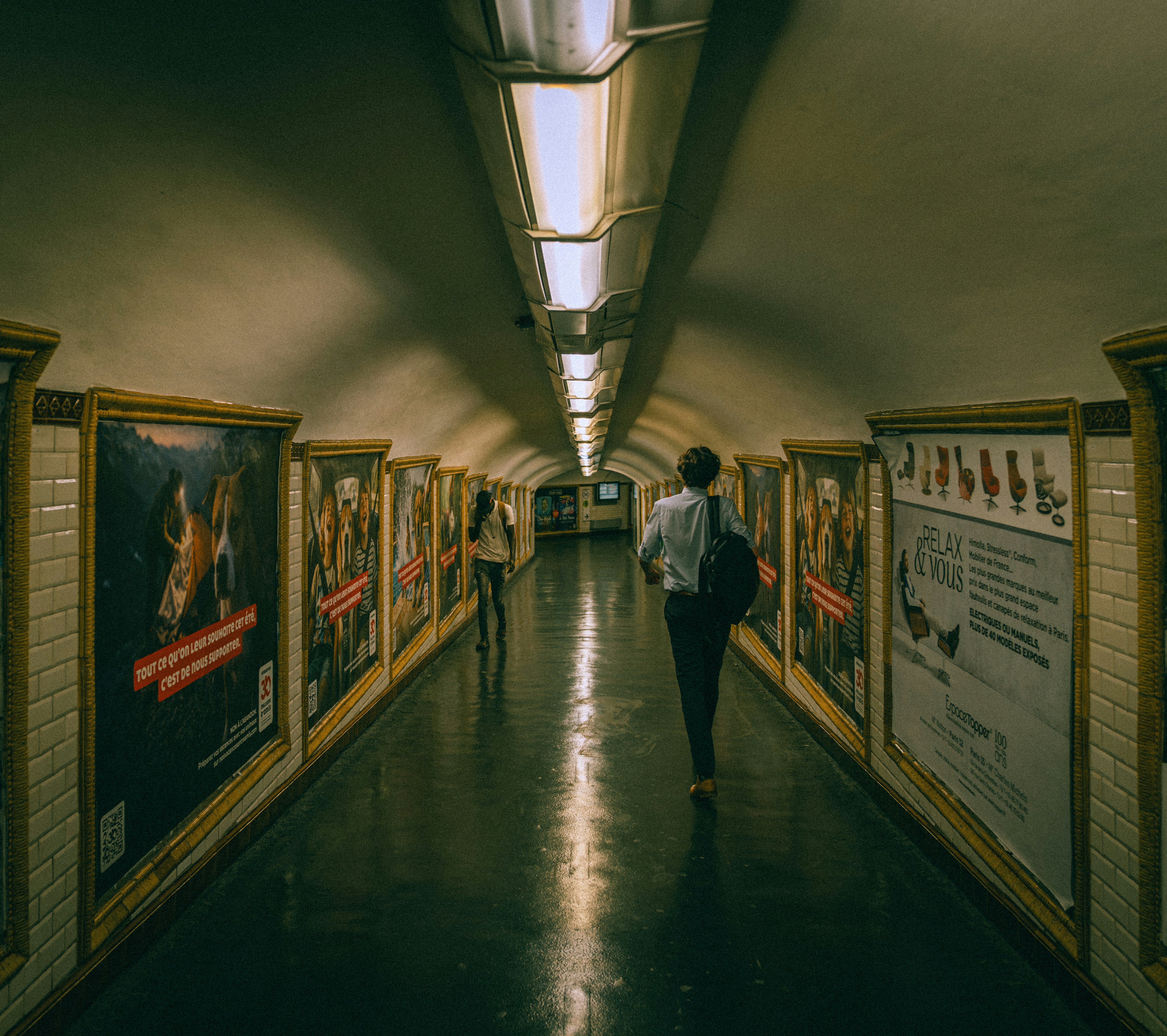 Midway in Light: A lone traveler in the underground corridor