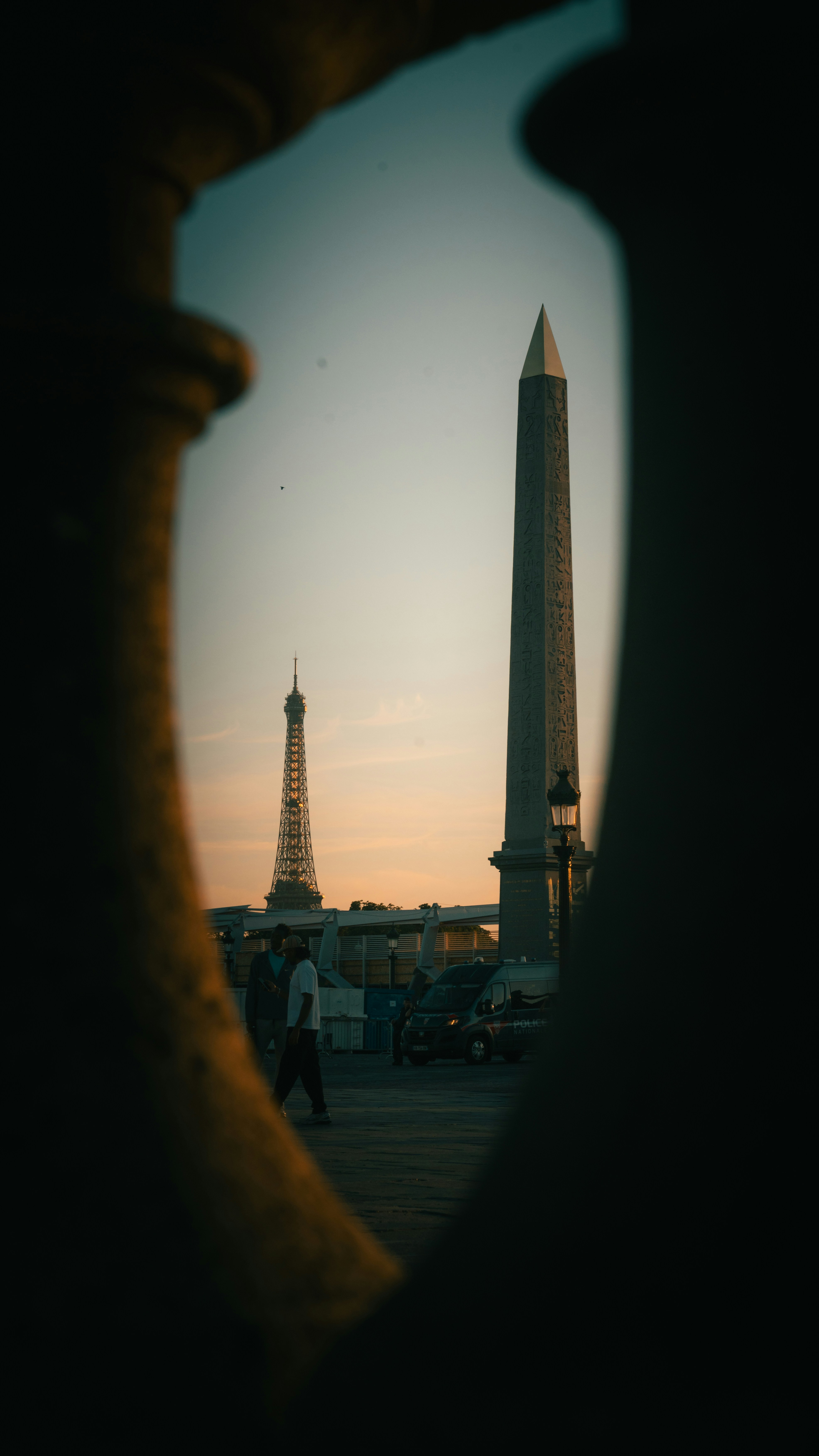 Distant Obelisk Framed by Architecture and Sky