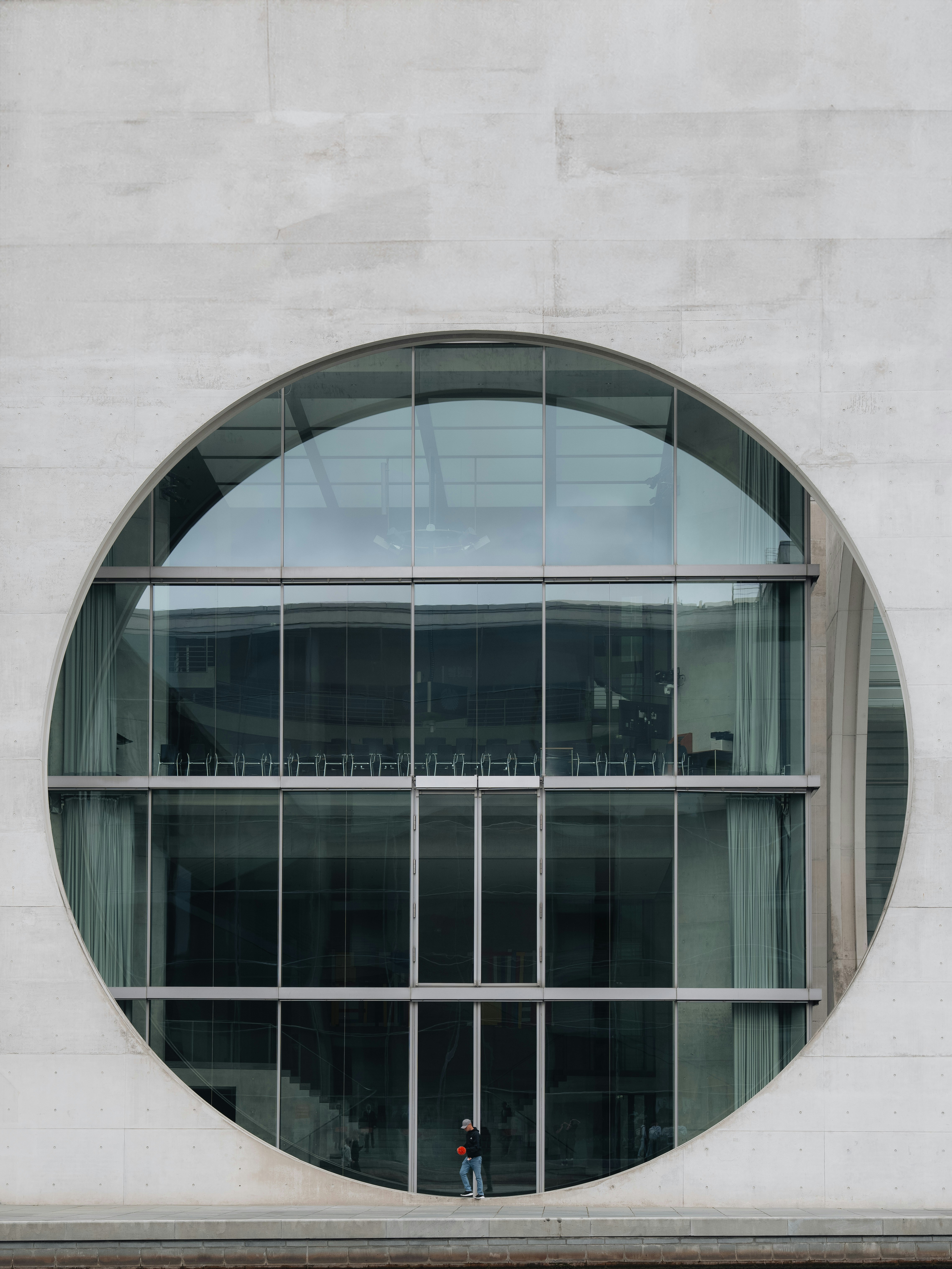 Circular Portal: A solitary figure at the base of a moonlit window