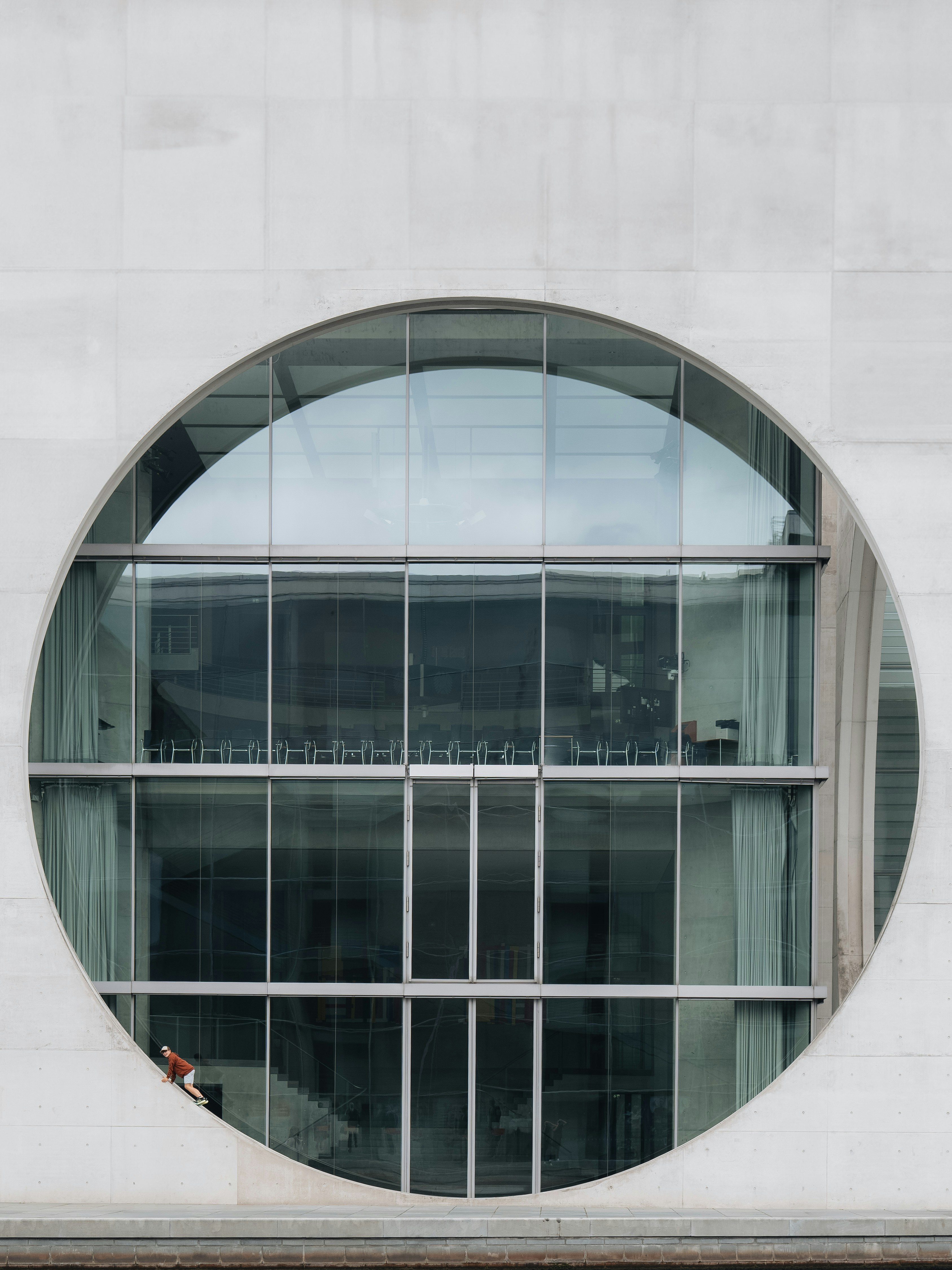 Circular Glass Window Framing a Modern Facade