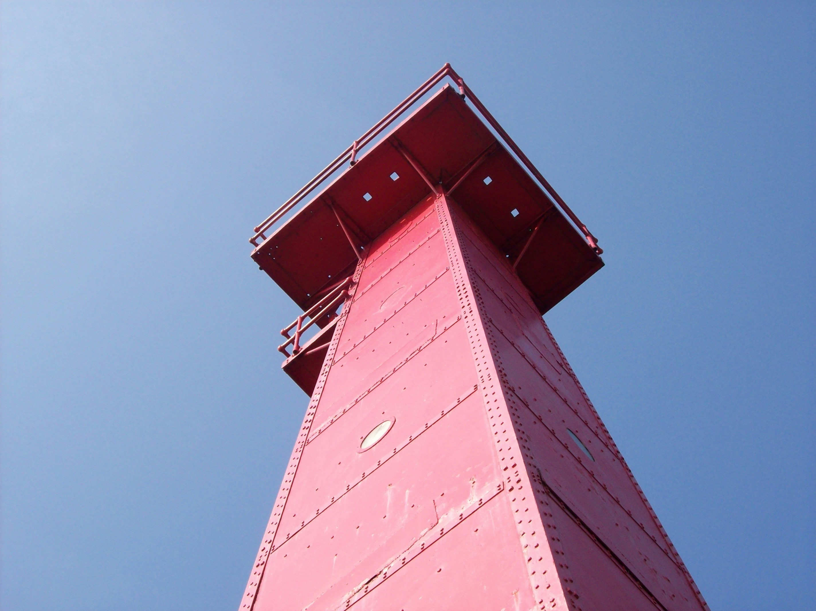 Red Observation Tower Reaching Toward a Clear Sky