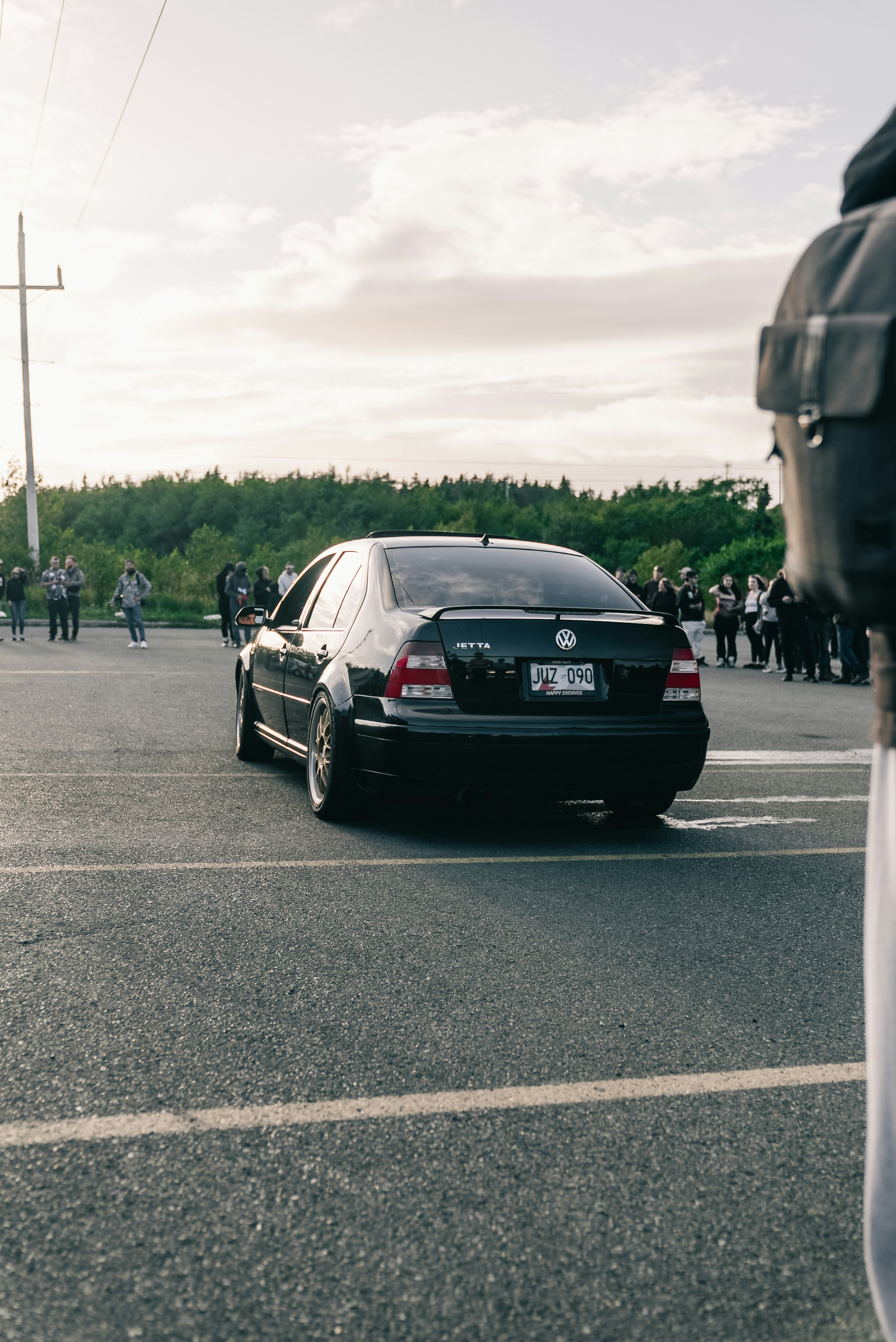 Midfield Mirage: A Quiet Stare Down of a Black VW in the Parking Lot