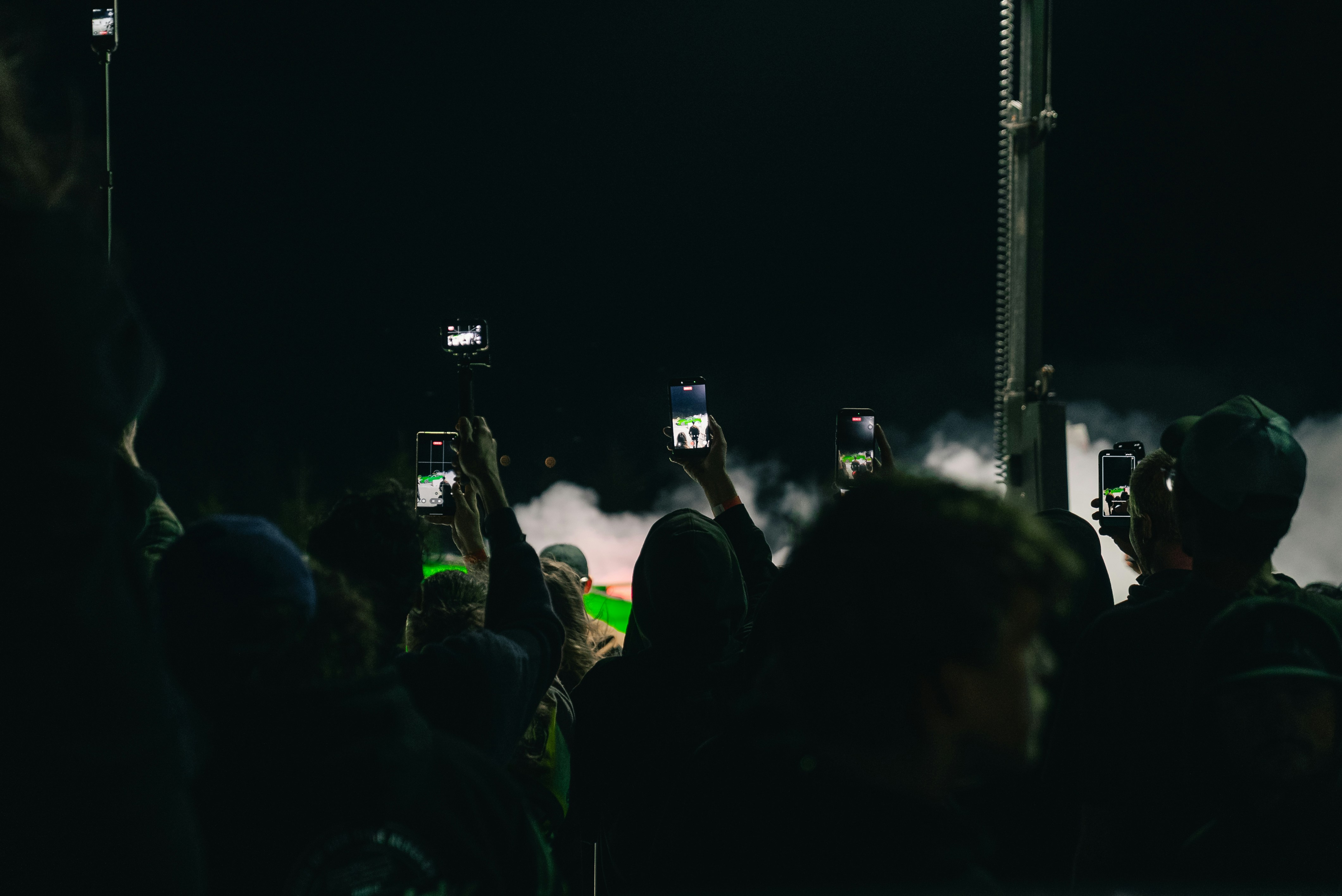 Luminous Rectangles: Neon Screens Capturing a Nighttime Crowd