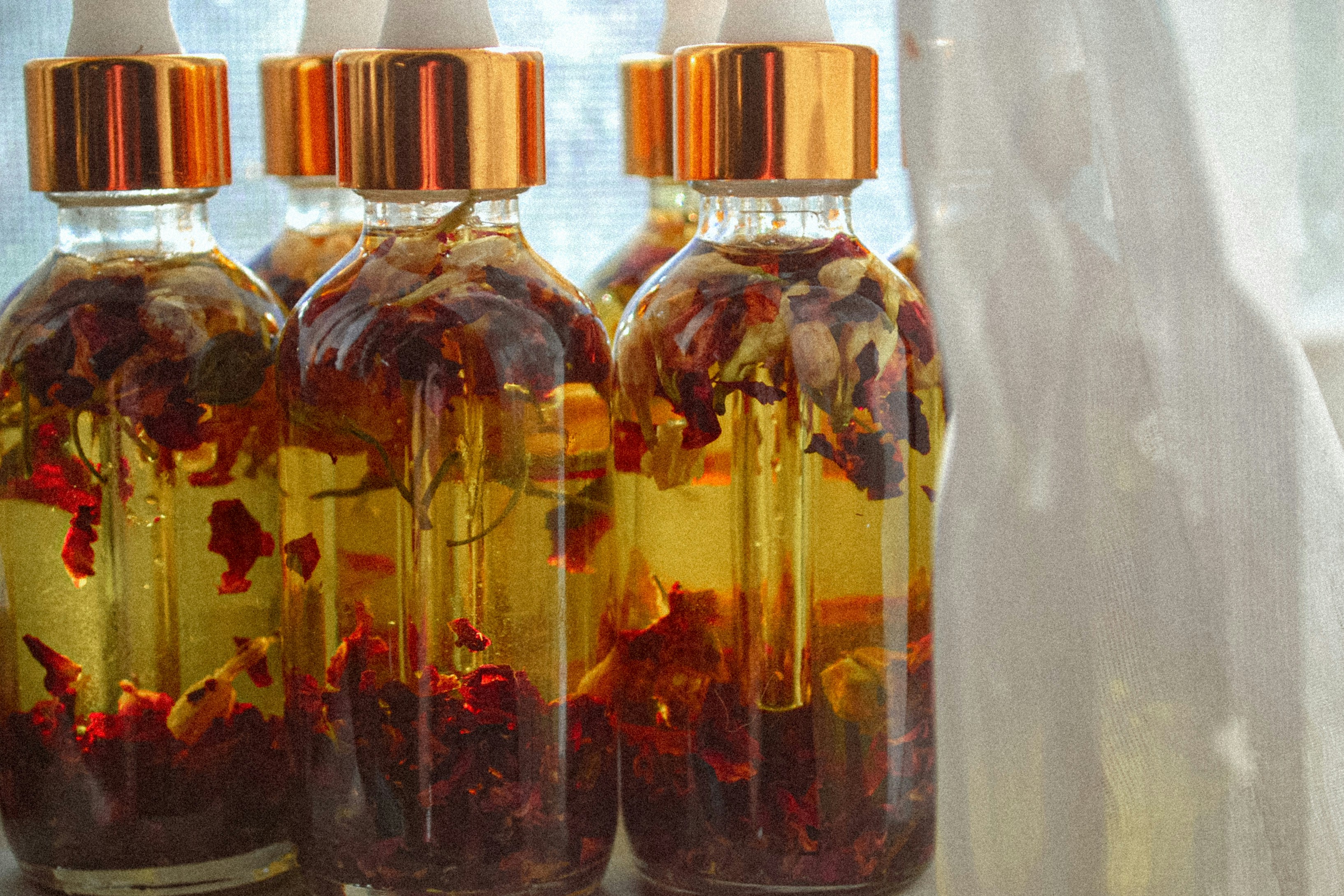Amber Elixirs in Glass: A Row of Golden Bottles on a Backlit Shelf