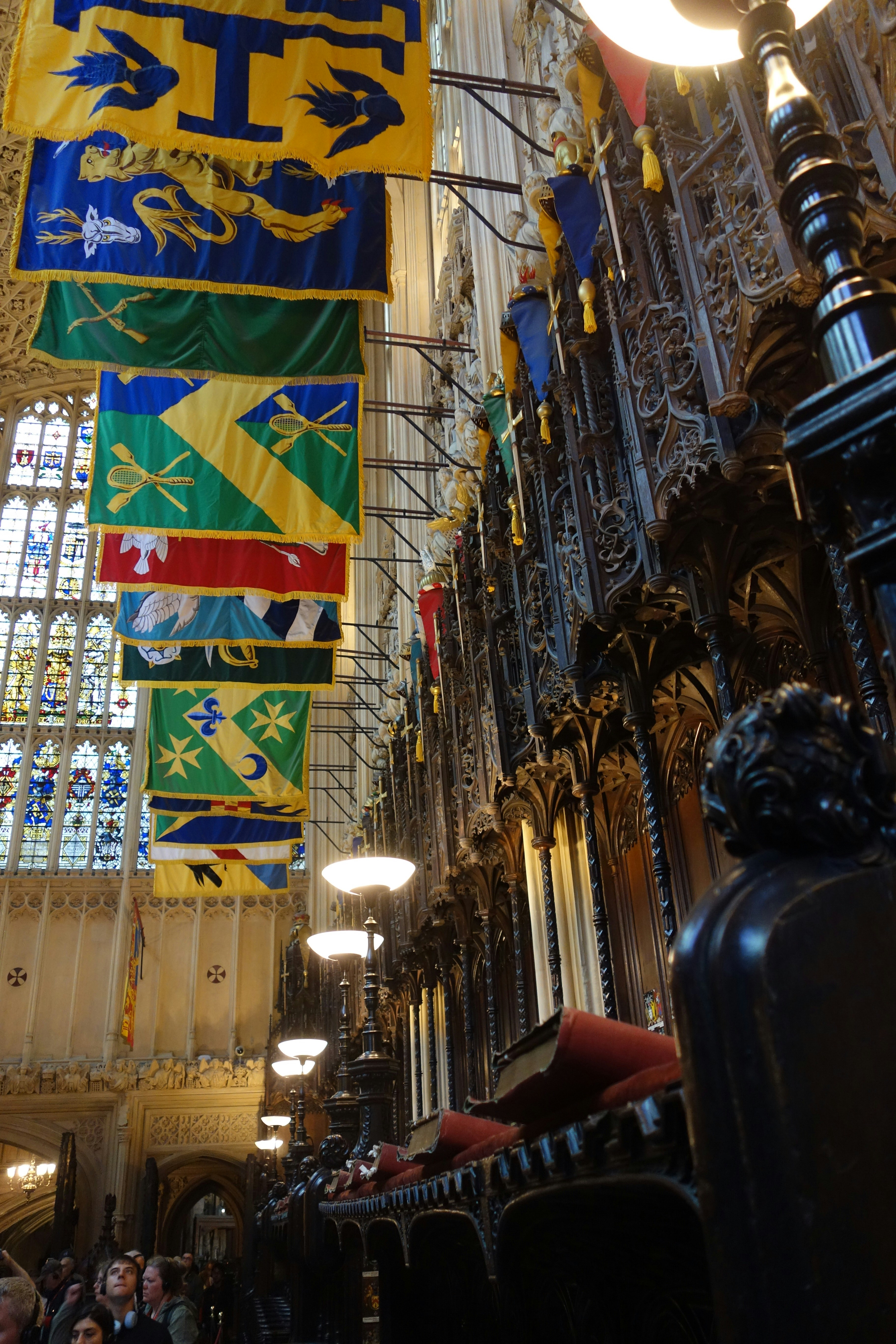 Flags and Gothic Arcades: A Cathedral Hall Awash in Colorful Banners