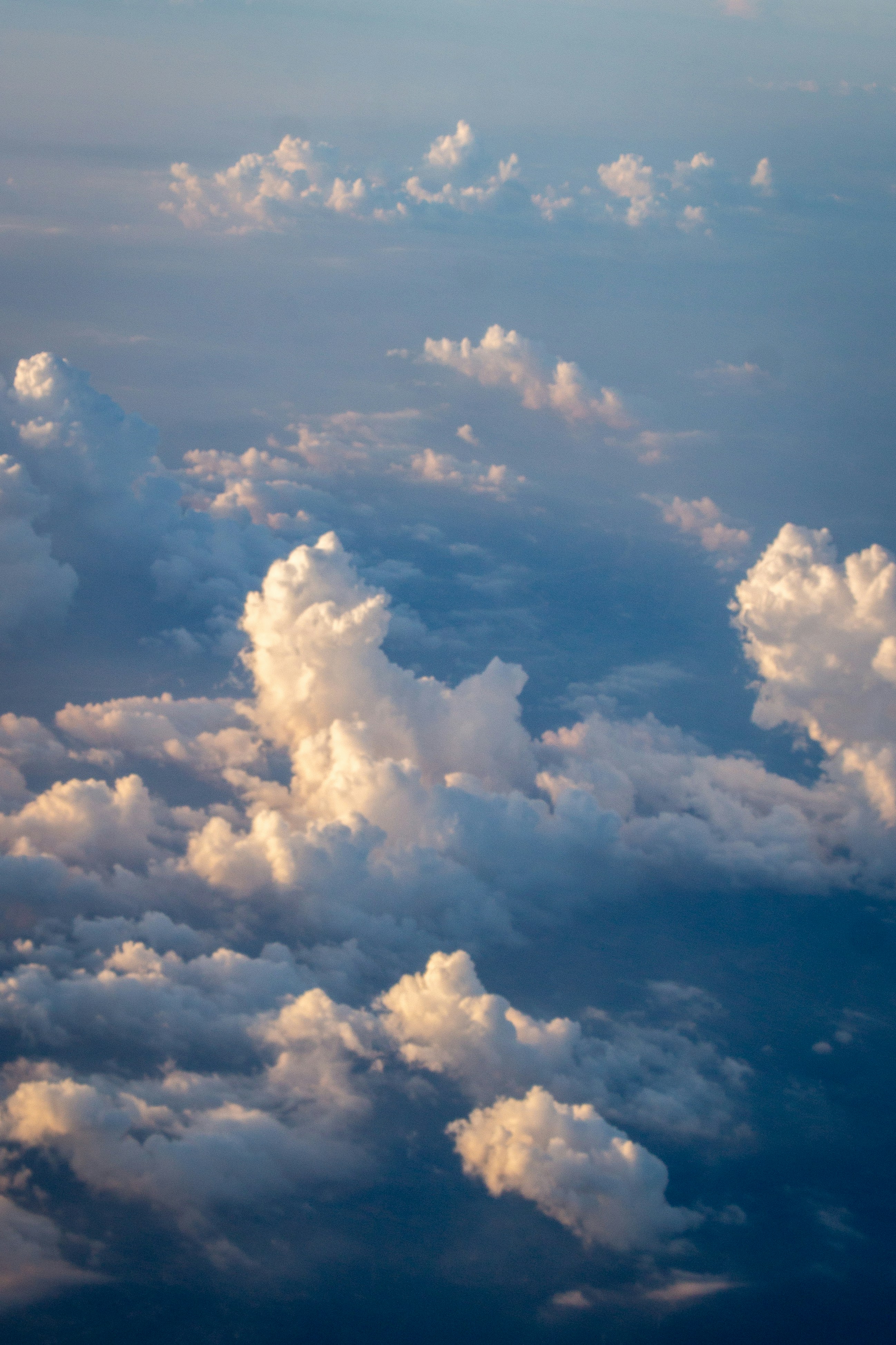 Sunlit Cloud Cathedral Rising Over a Moody Blue Sky
