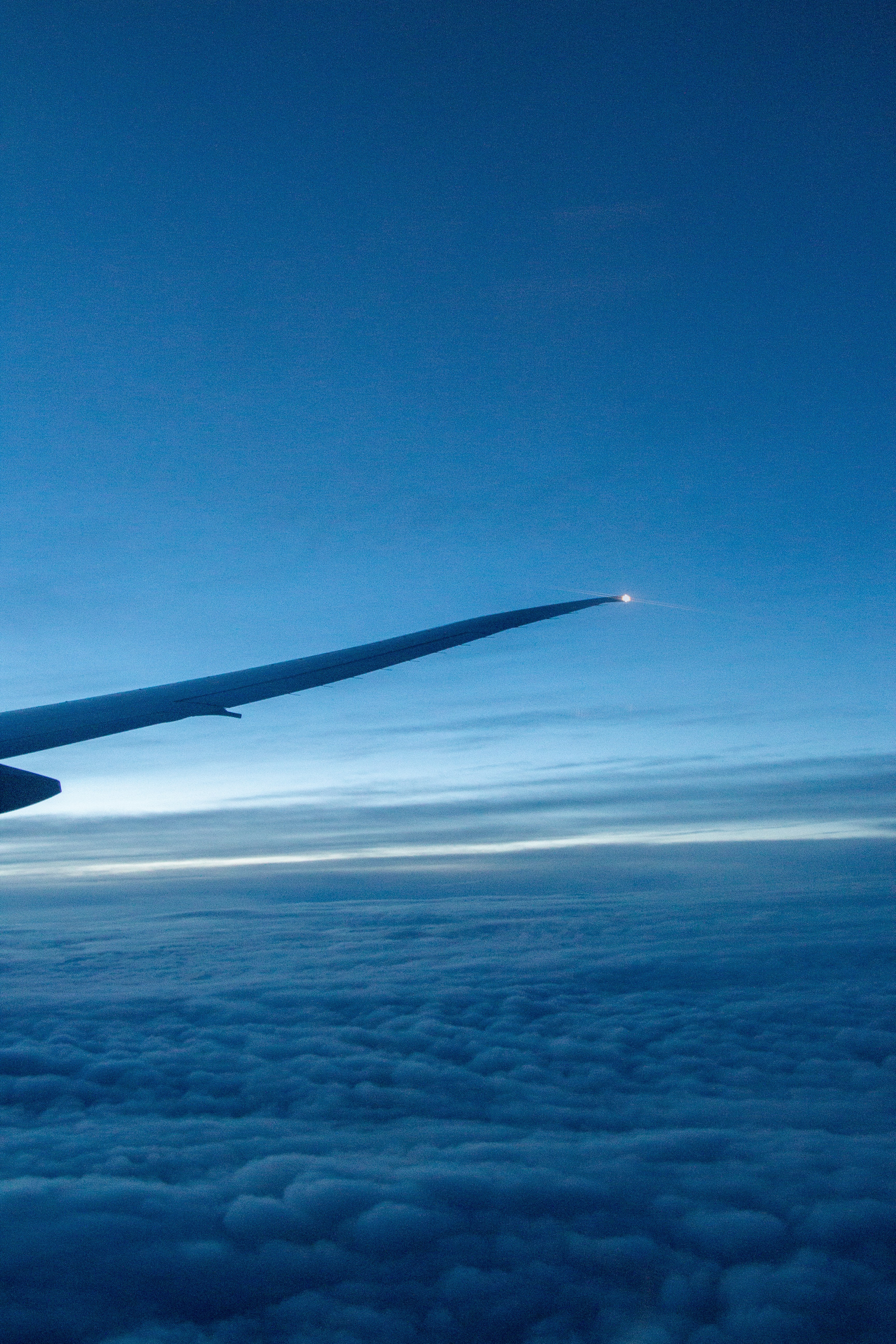 Wingtip at Dusk: A Quiet Horizon Through Cloud Ocean