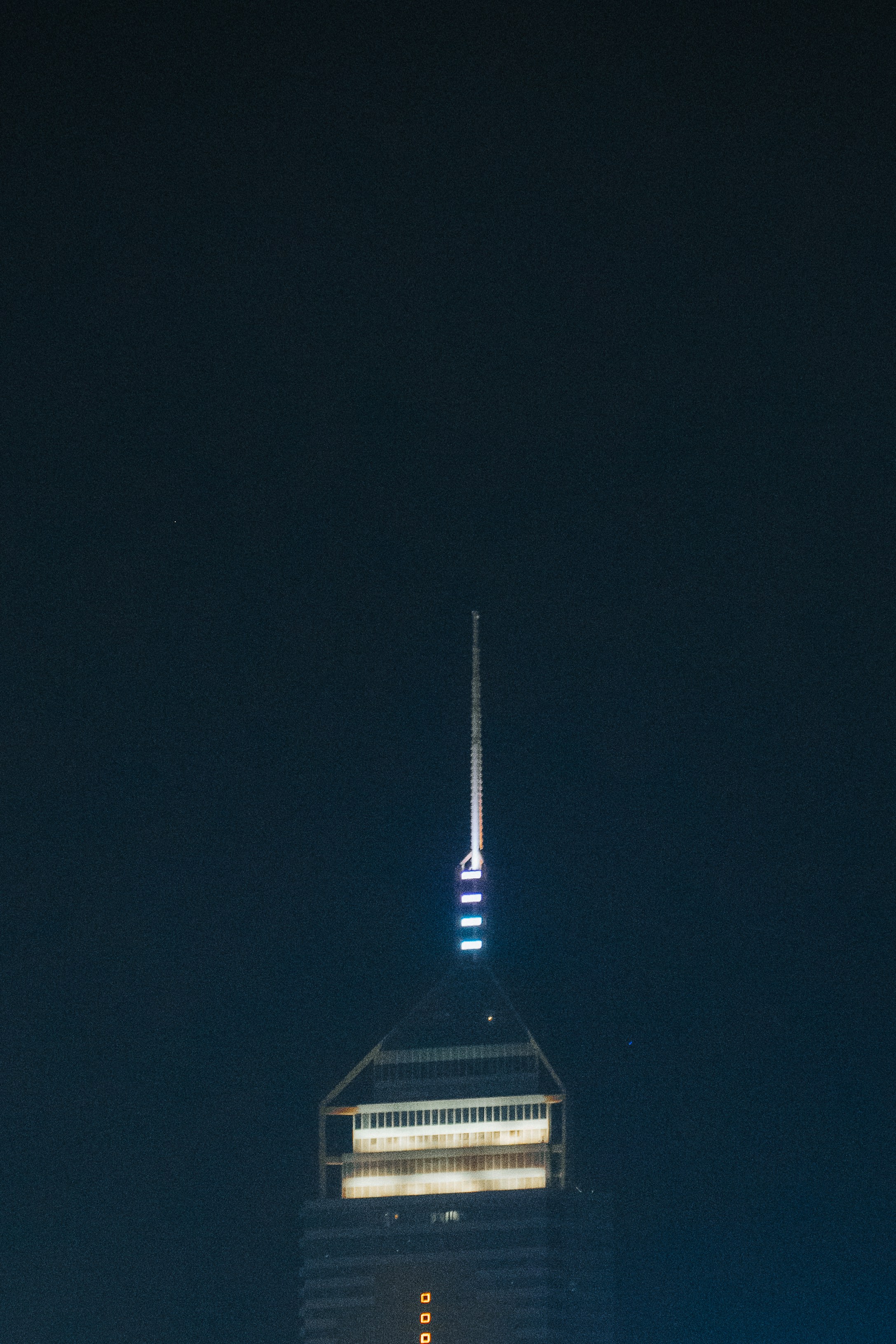Night Spire: A Needle of Light Crowned Above the City