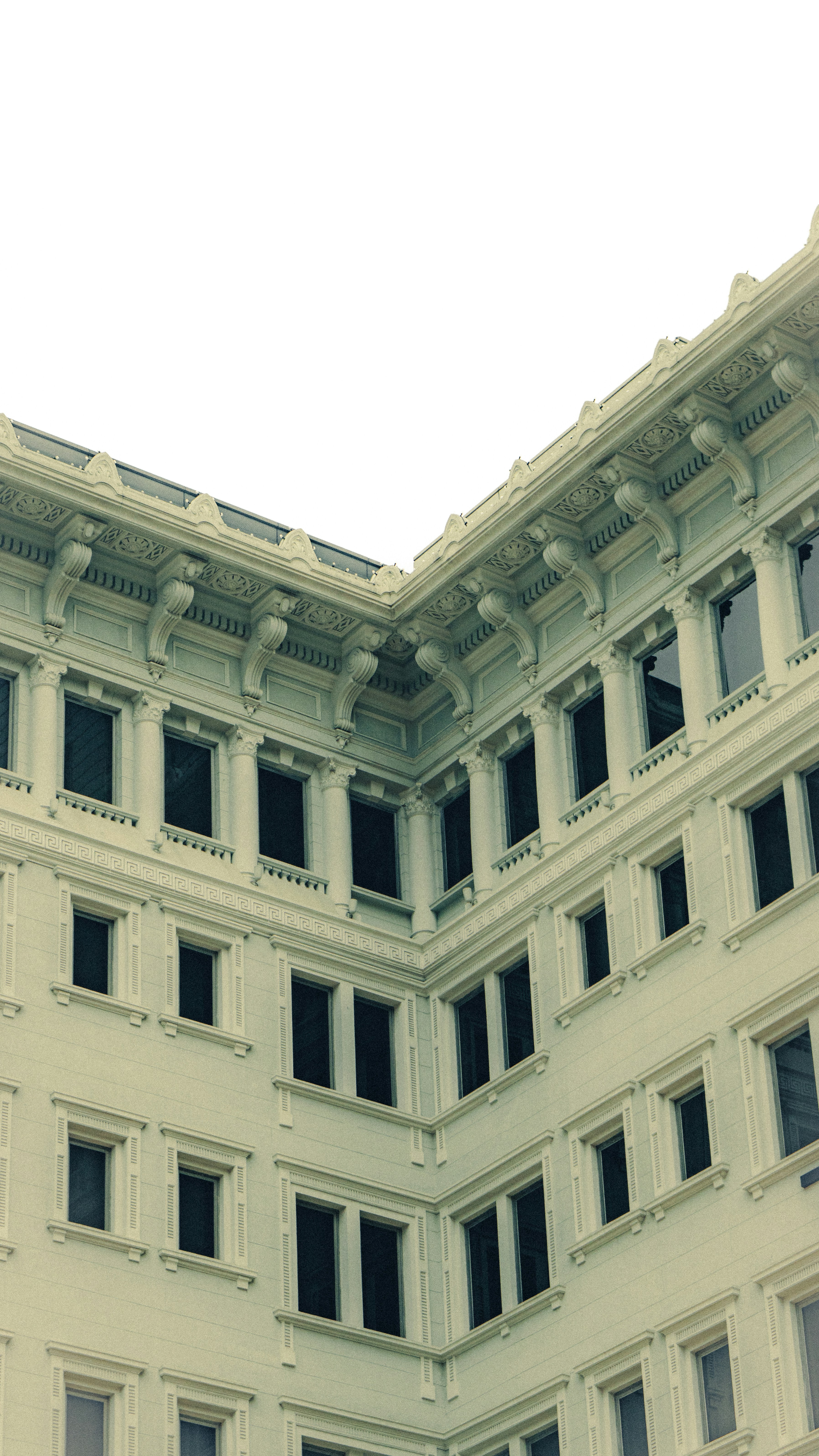 Corner of a Historic Facade: Sunlit Ornamentation and Vertical Lines