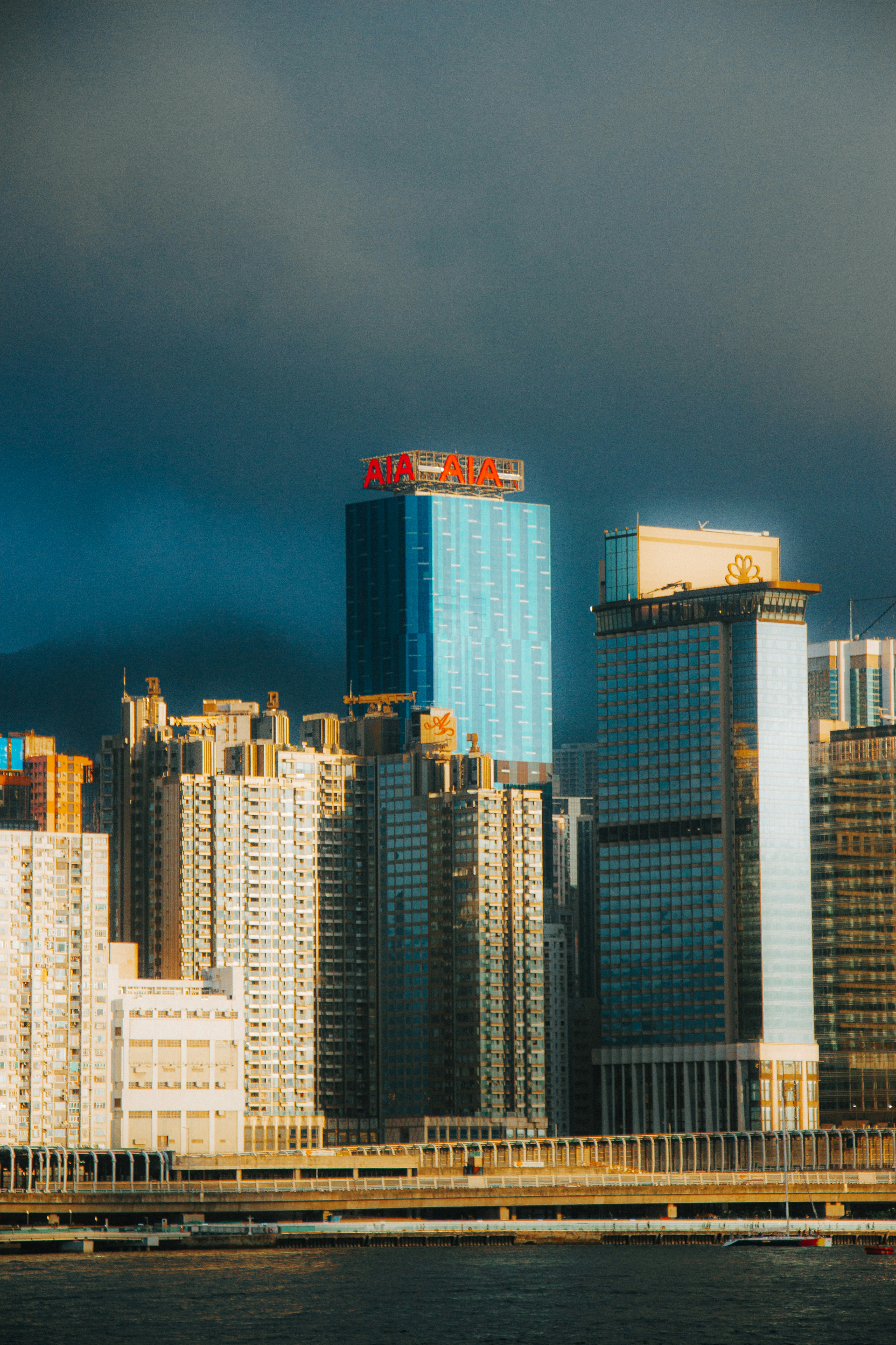 Skyline Sentinel: A Blue-Tinted Tower Among Golden Riverside