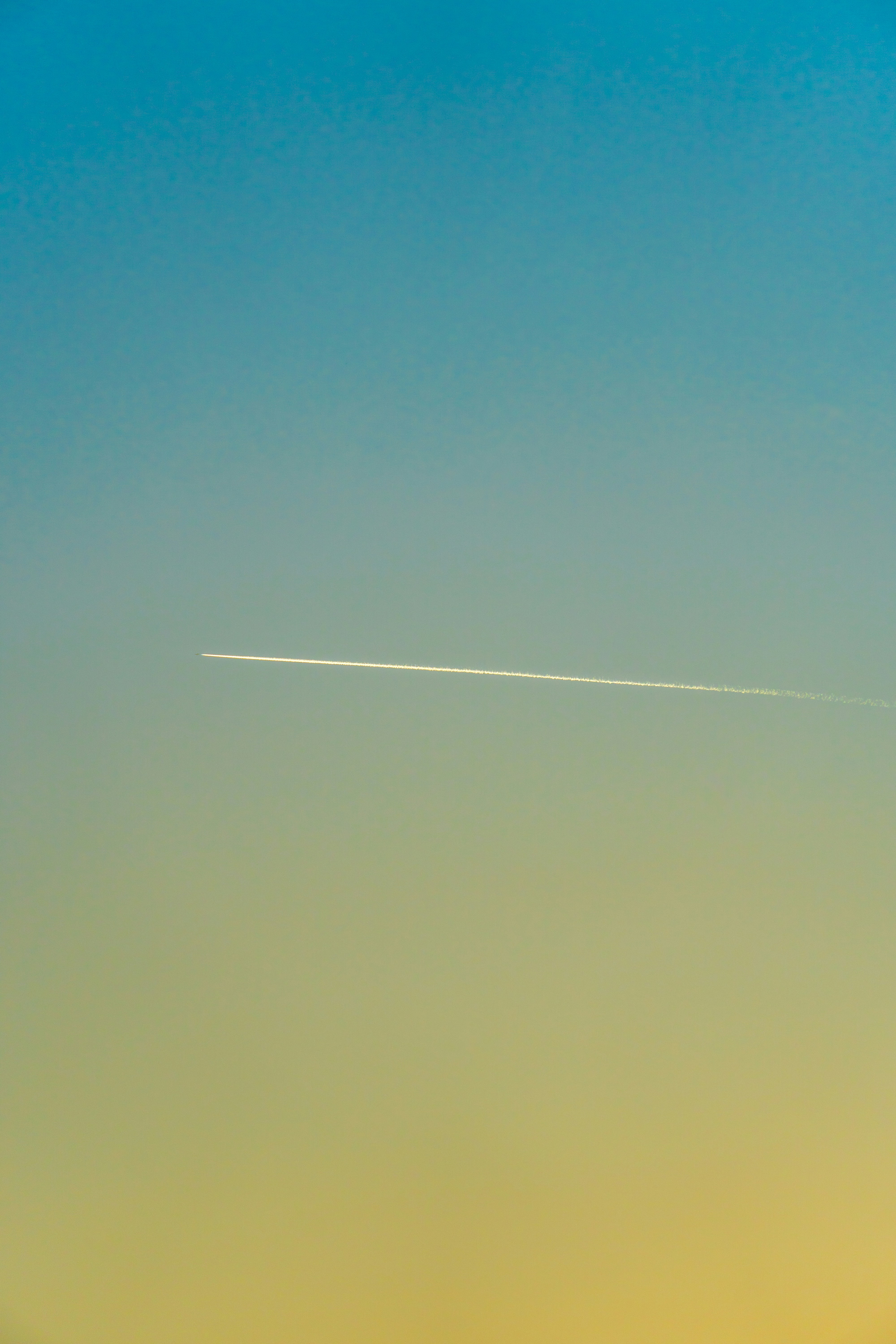 Jet Arc Across a Dreamy Gradient Sky