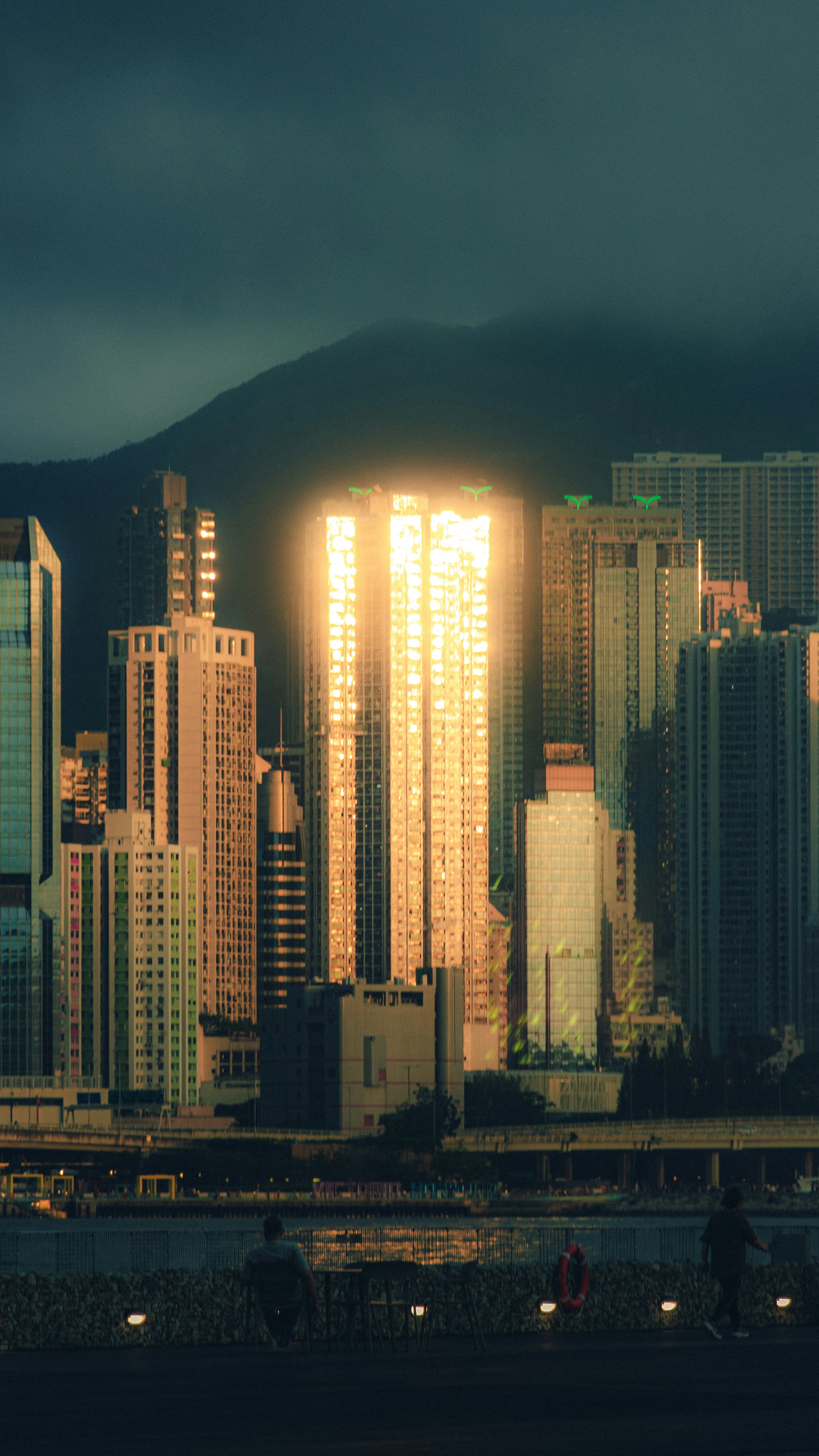 Gilded Towers: Sunset Glare on a Harbor Skyline