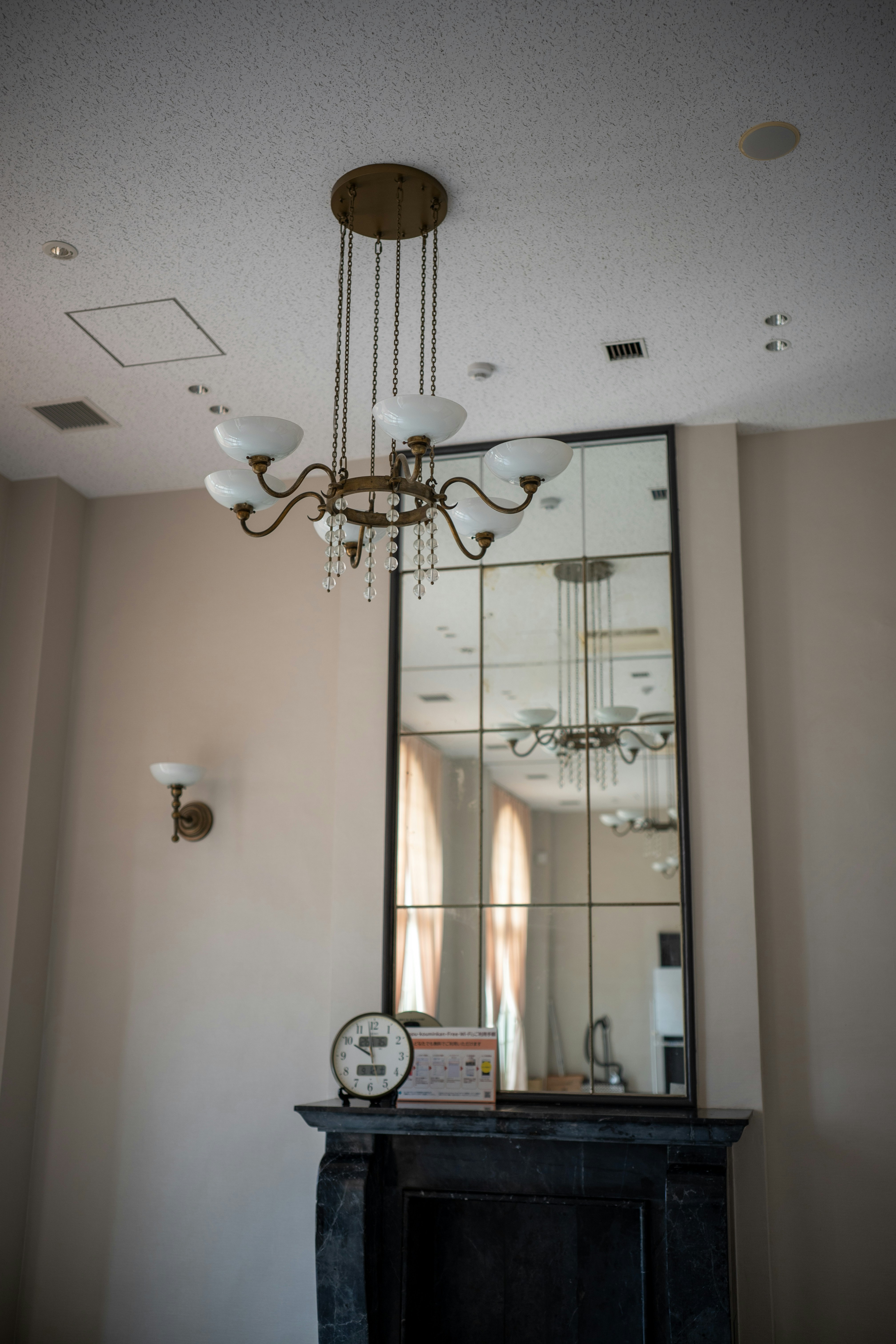 Elegant chandelier reflections in a tall foyer mirror