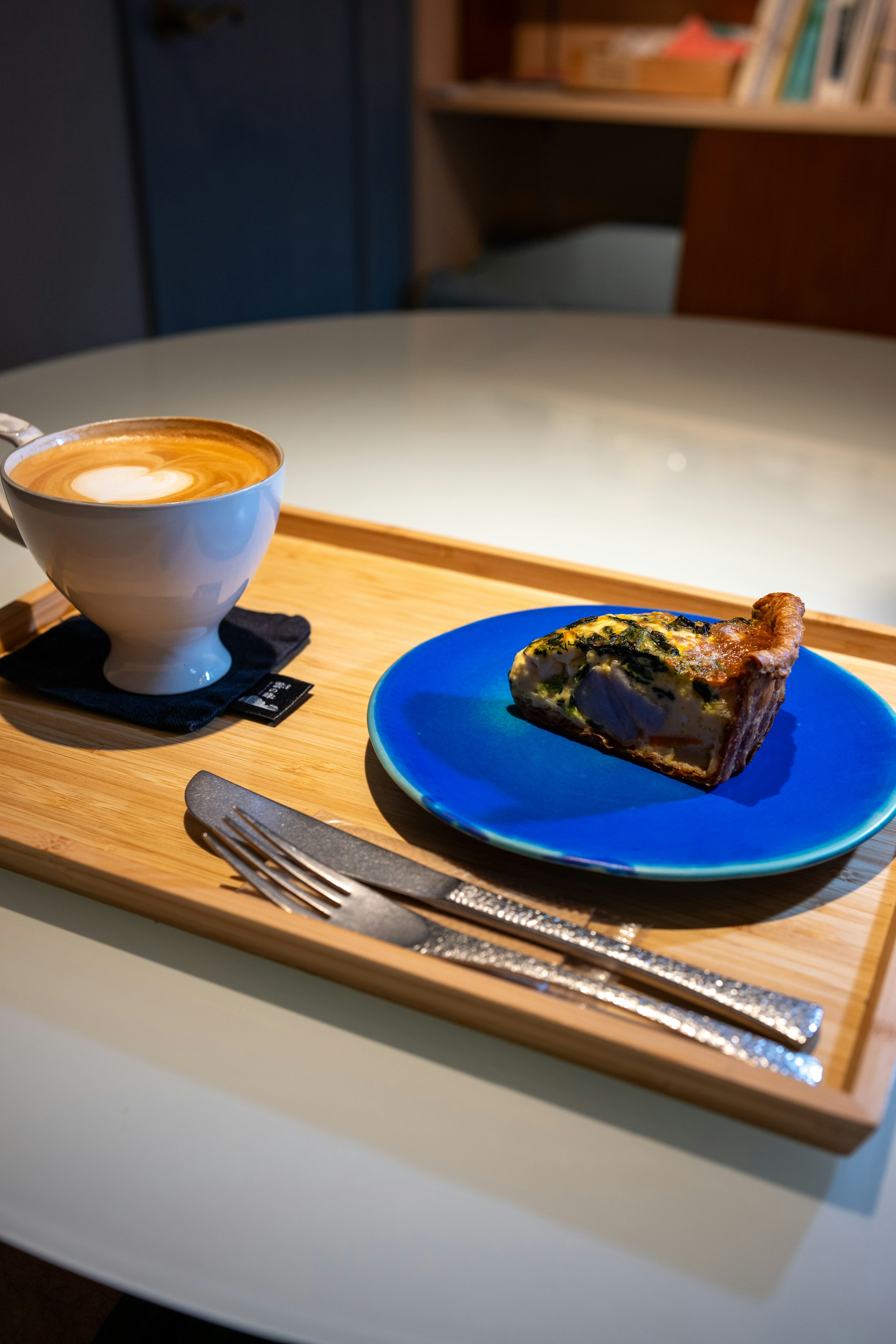 Cappuccino and Slice: A Quiet Café Moment on a Wooden Tray