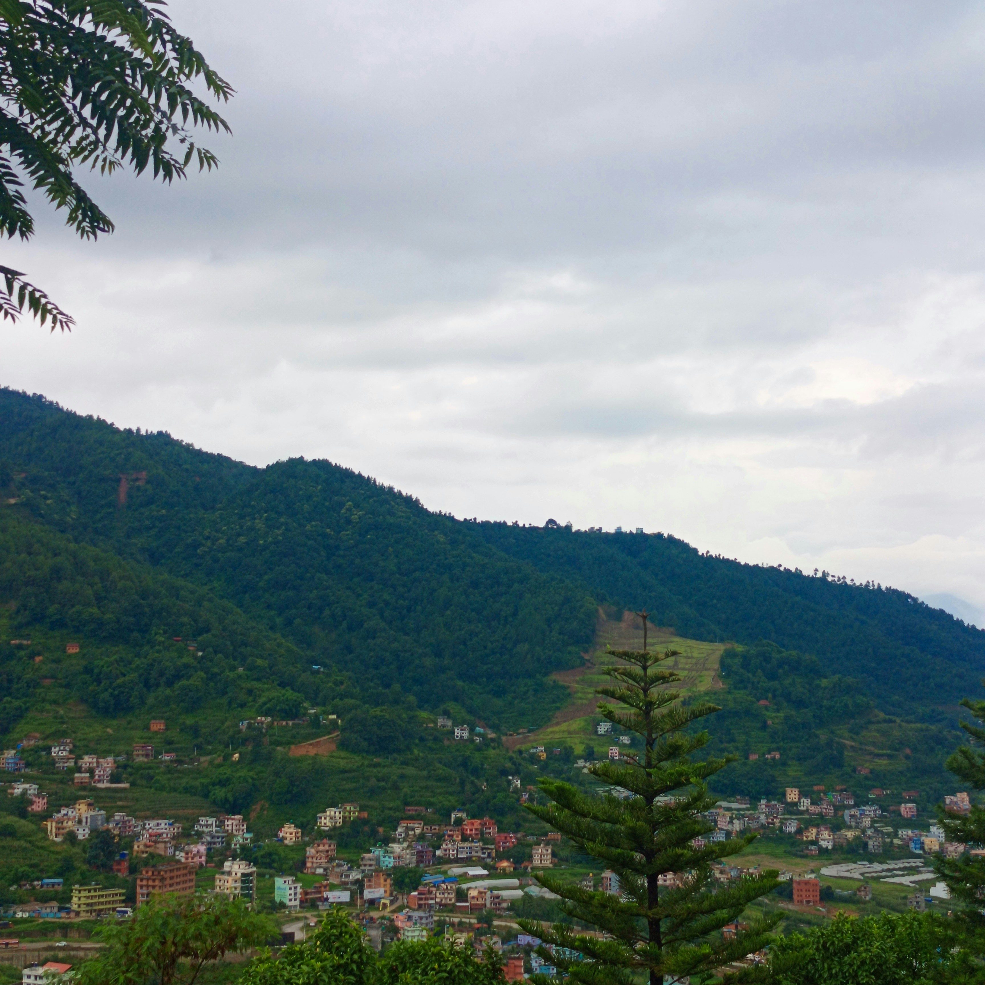 Terraced Valley Village Beneath Folded Cloudscape