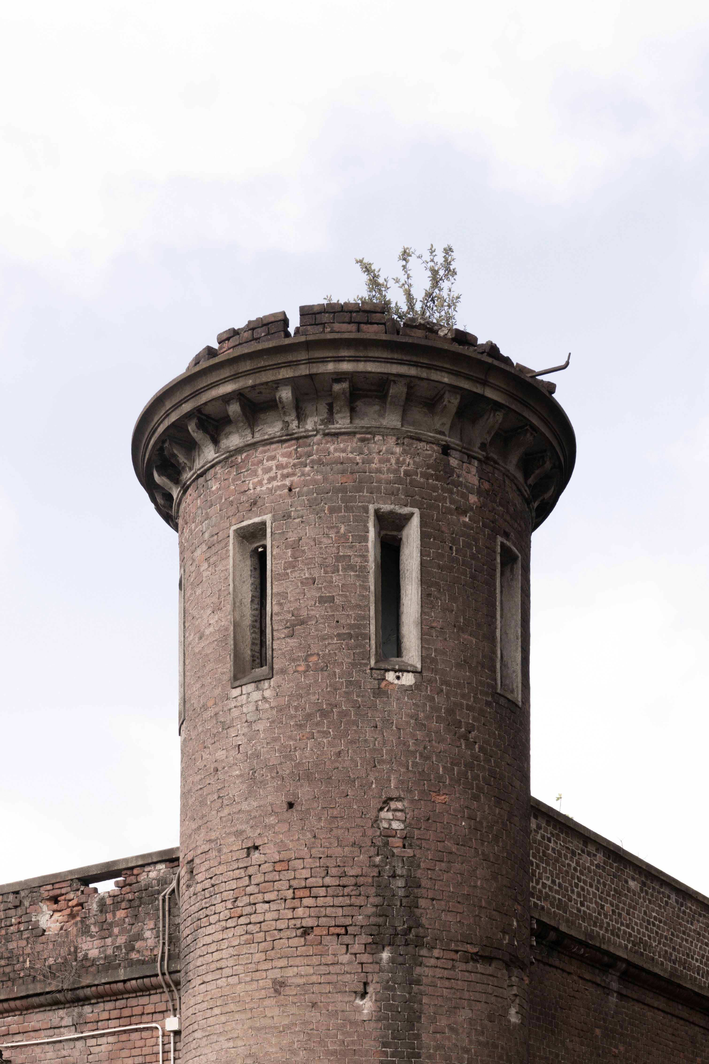 Circular Brick Tower Reaching Skyward Against a Quiet Sky