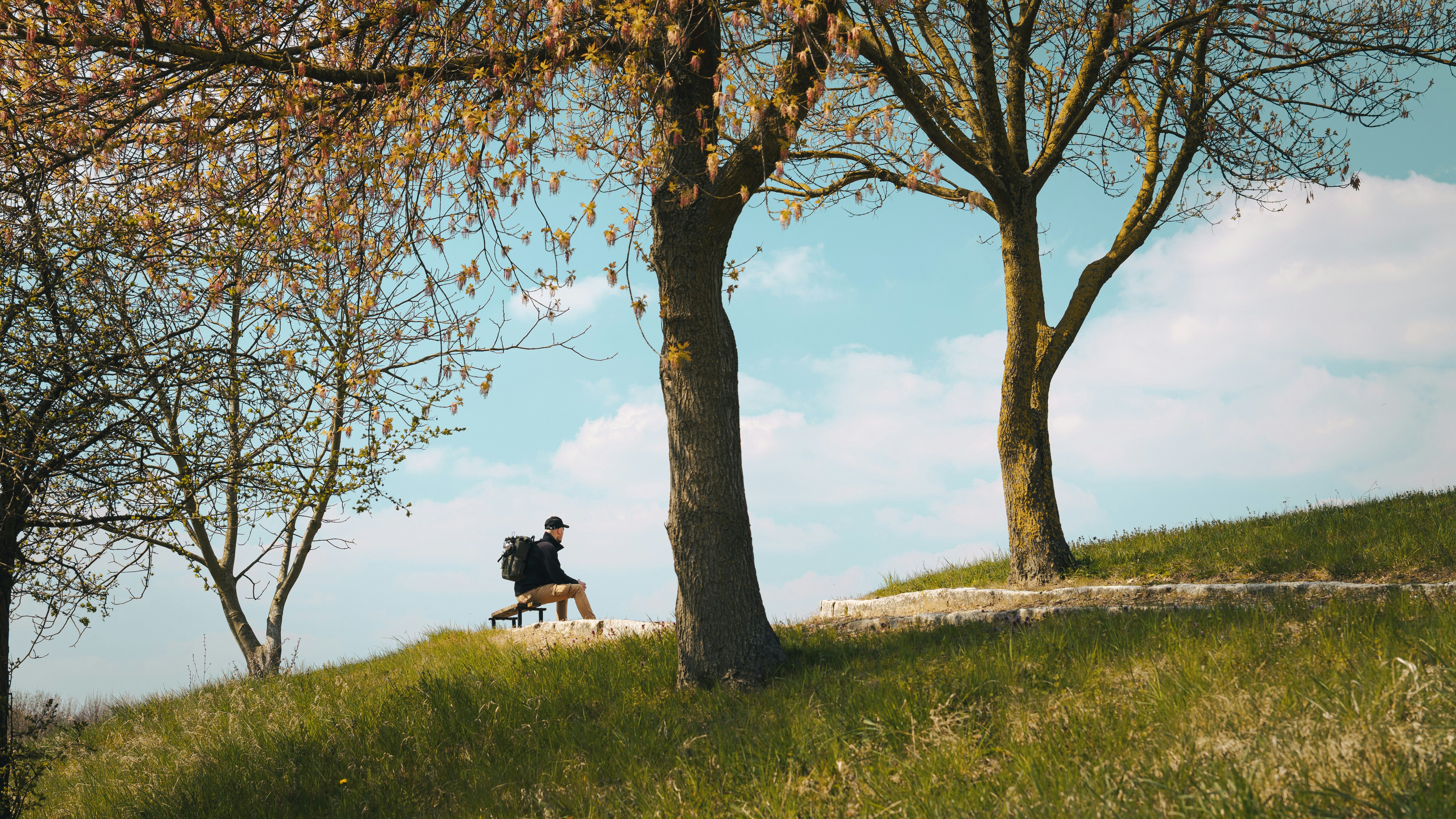 Strolling silhouette: a lone hiker on a sunlit hill