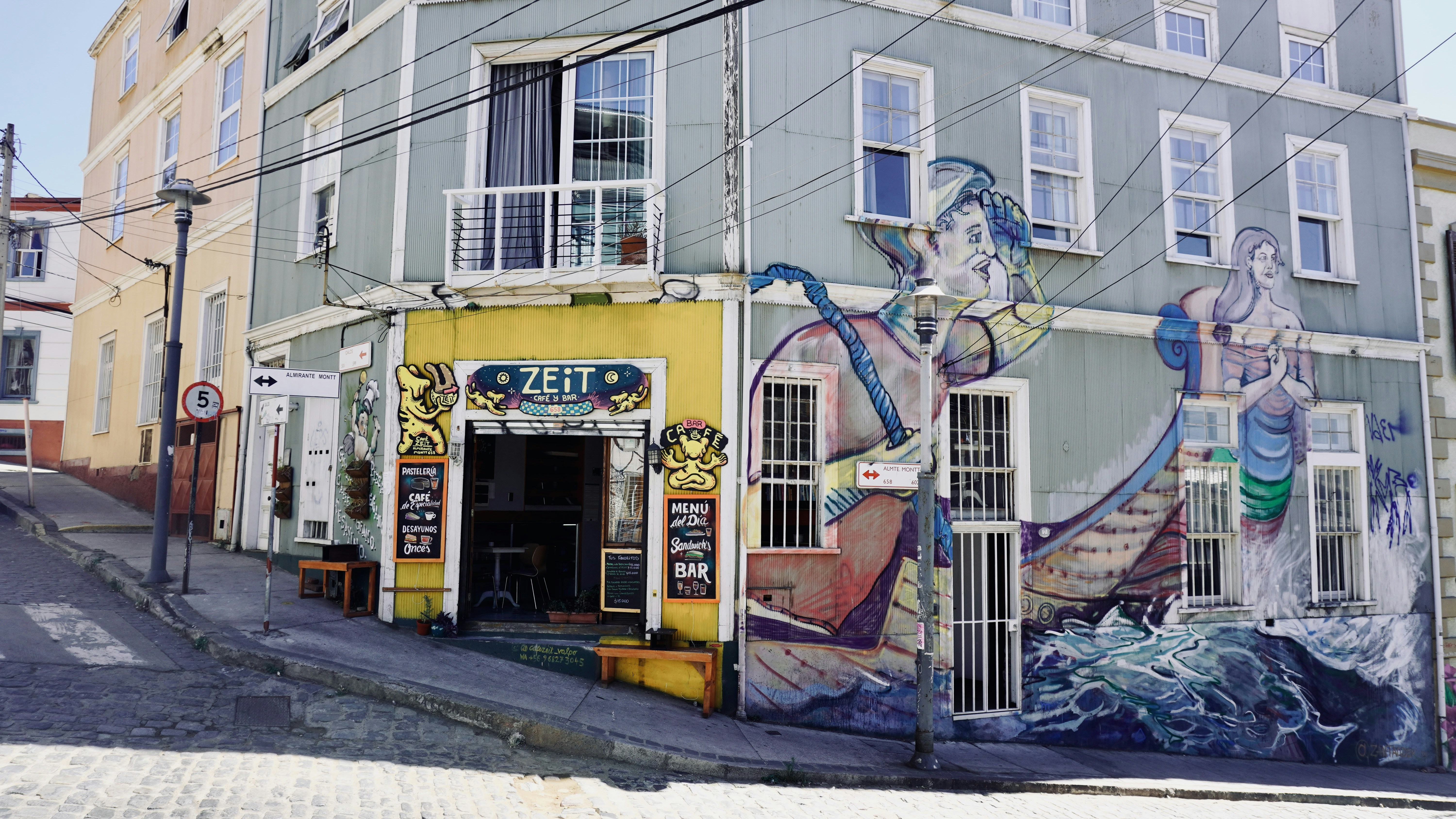 Mural-Front Café on a Sloped Lisbon Street