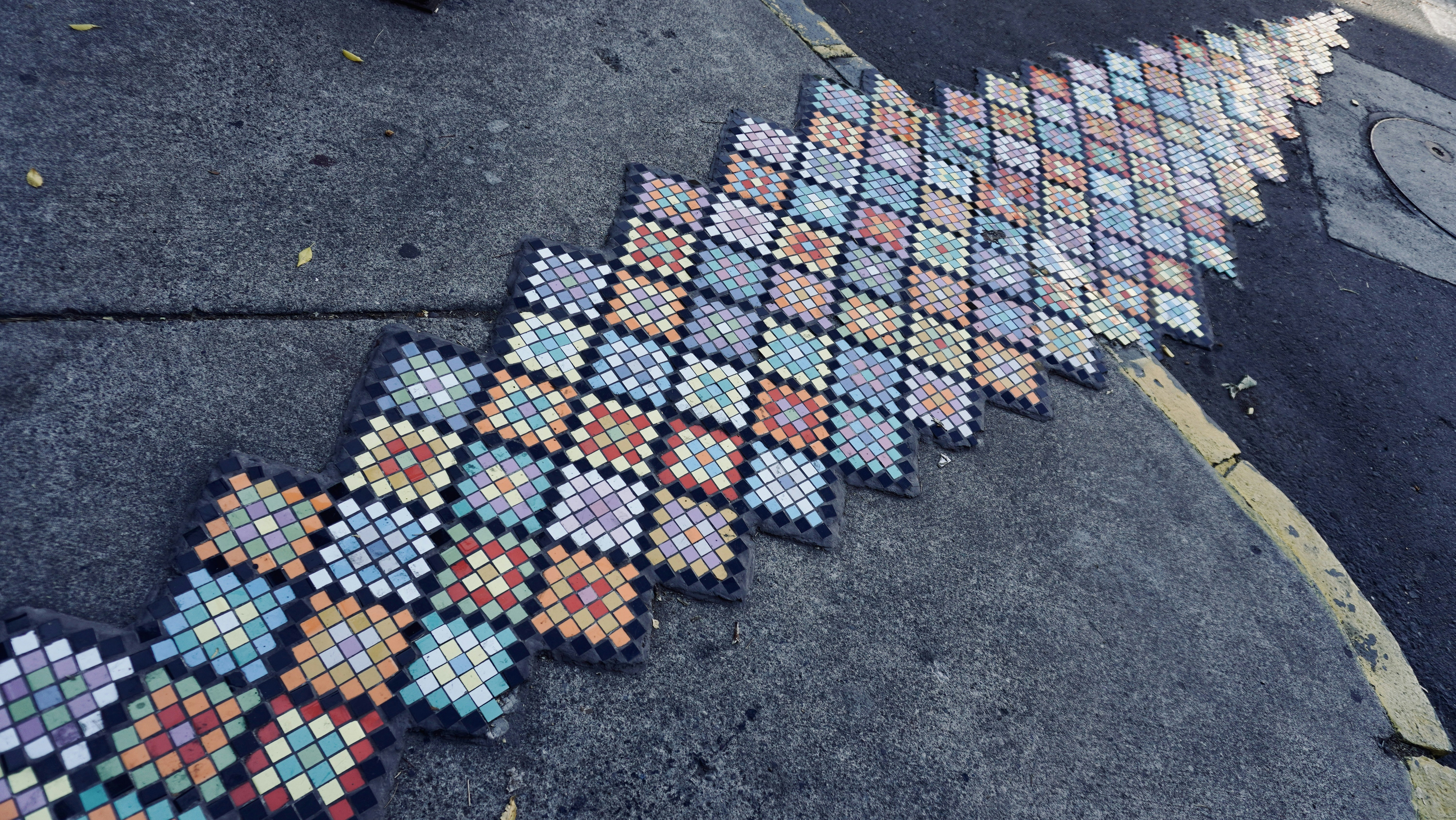 Diagonal Tile Mosaic Trail on a Rainy Street