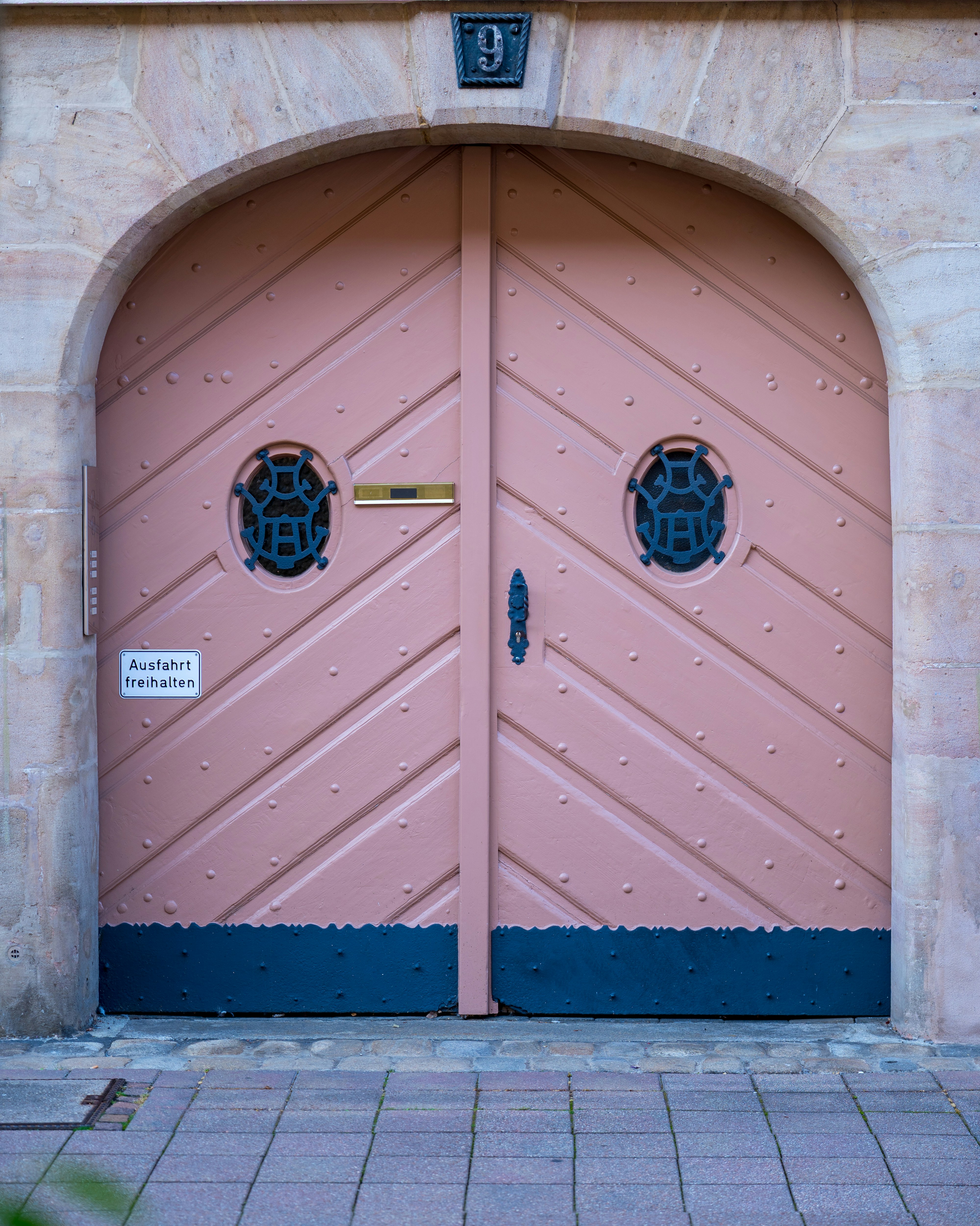Twin Pink Doors with Oval Grilles and Ironwork