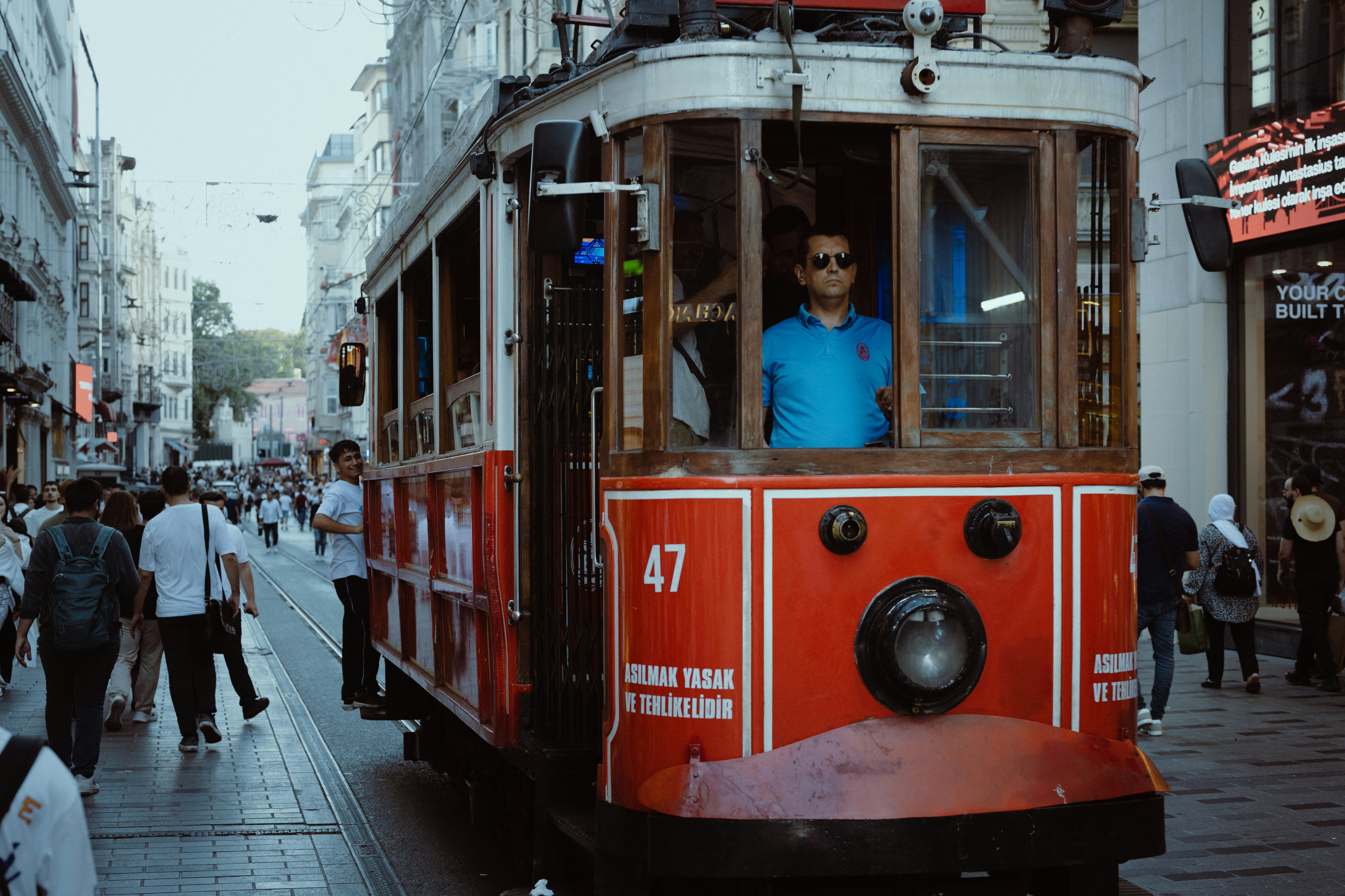 Red Streetcar on a Busy European Avenue