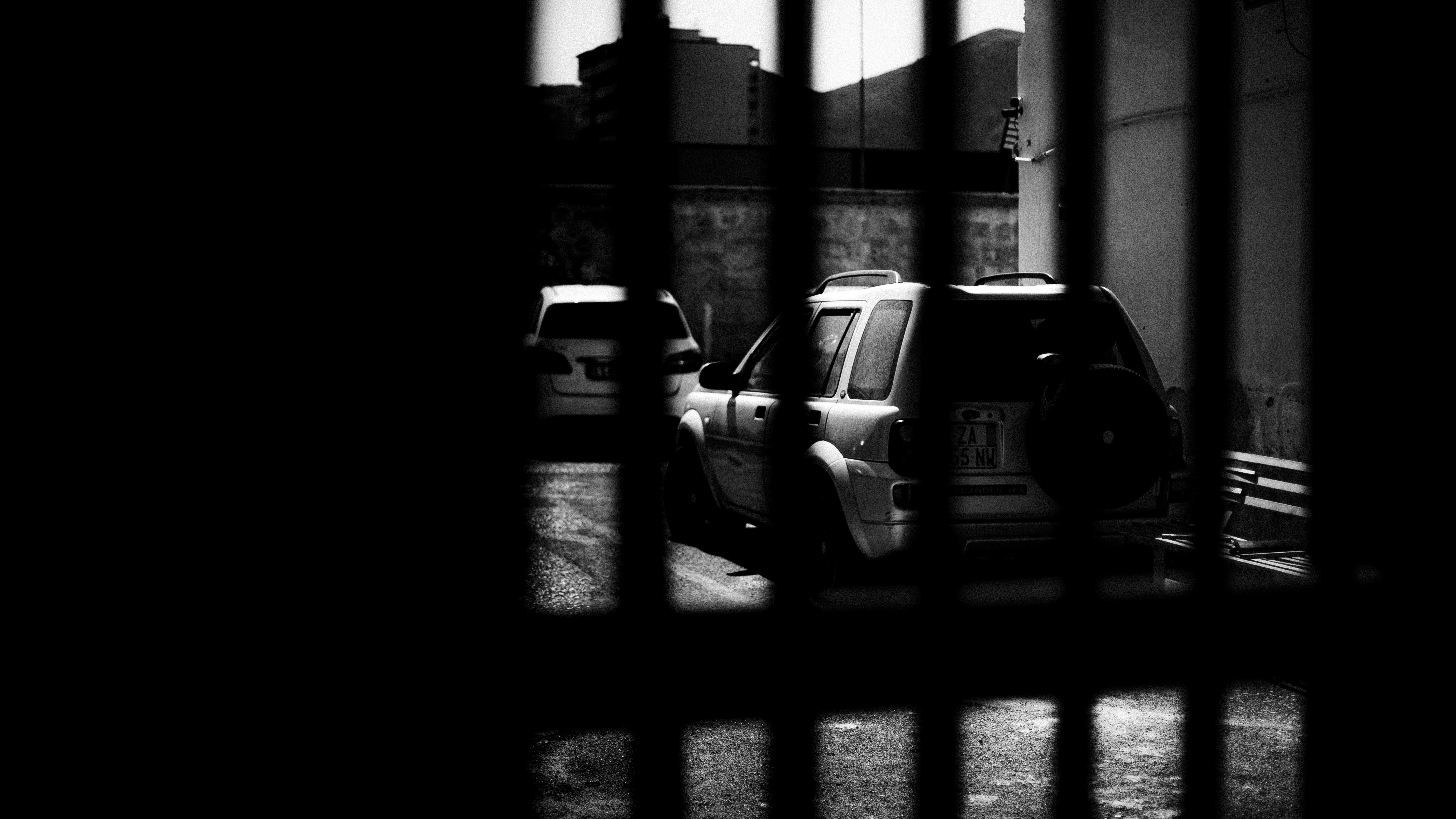 Shadowed Parking Lot Through Bars