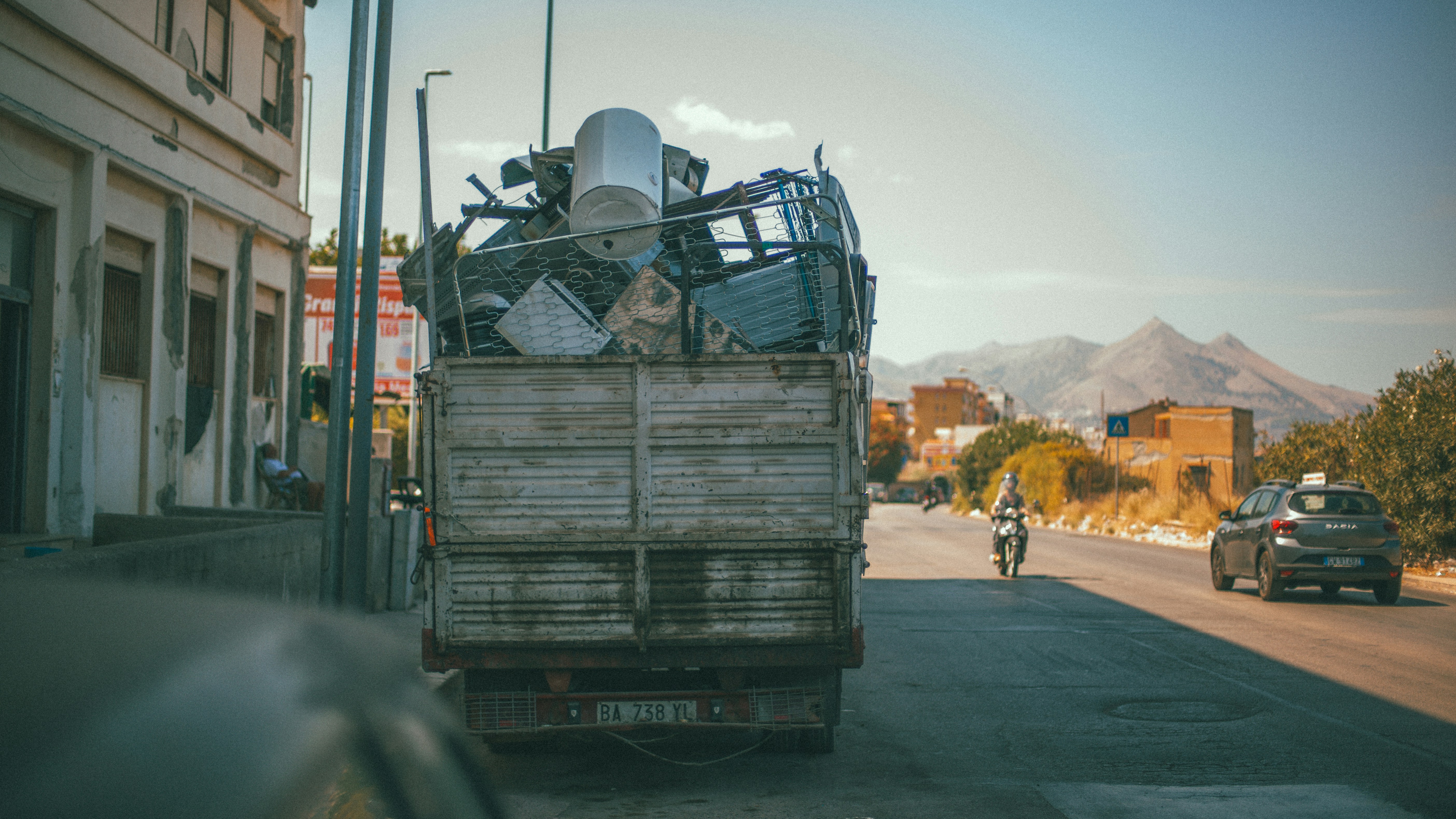 Harboring a Load: a weathered truck journeys through a sunlit desert town