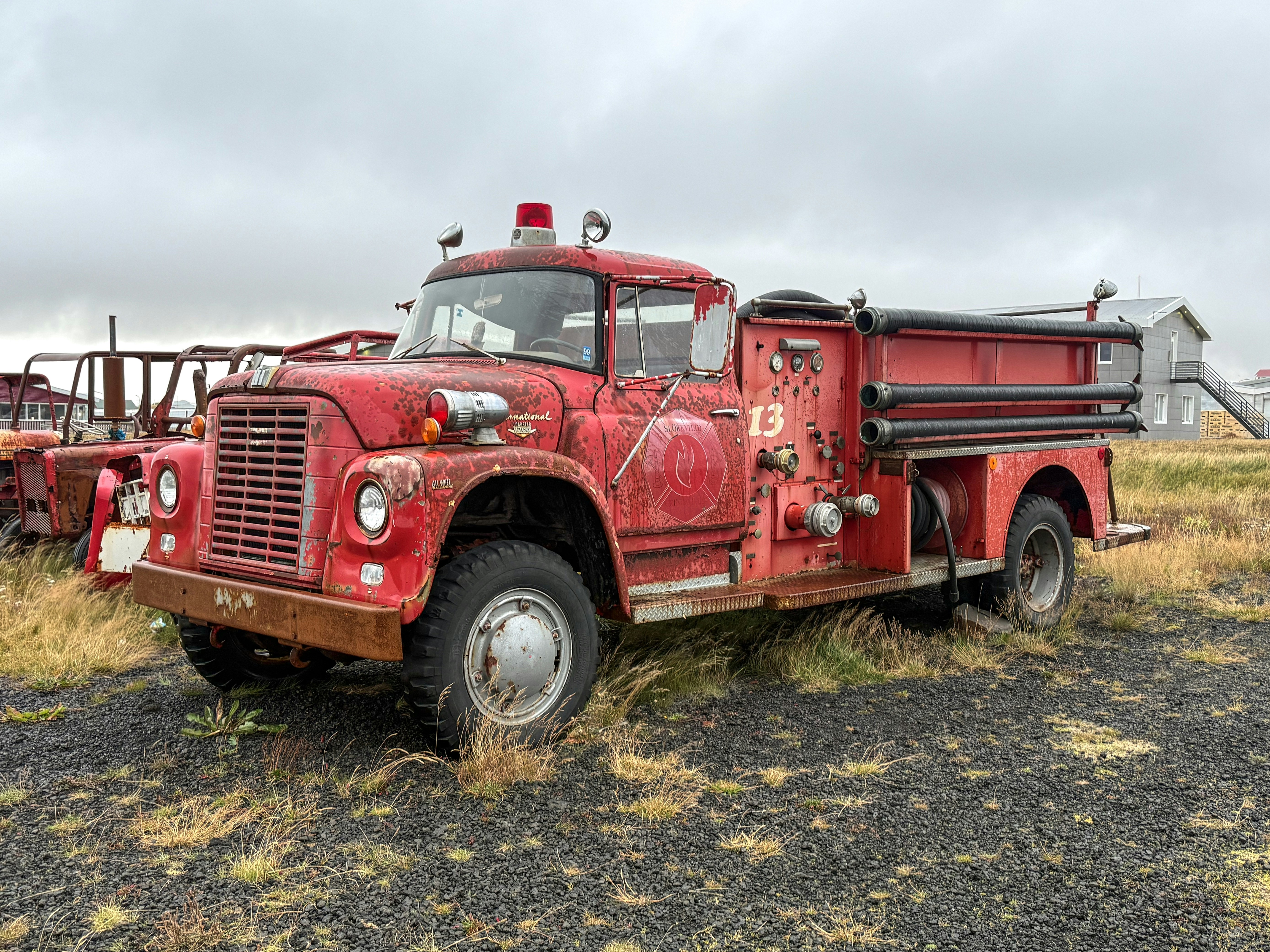 Red Legacy: Abandoned Fire Engine Resting in Prairie Light