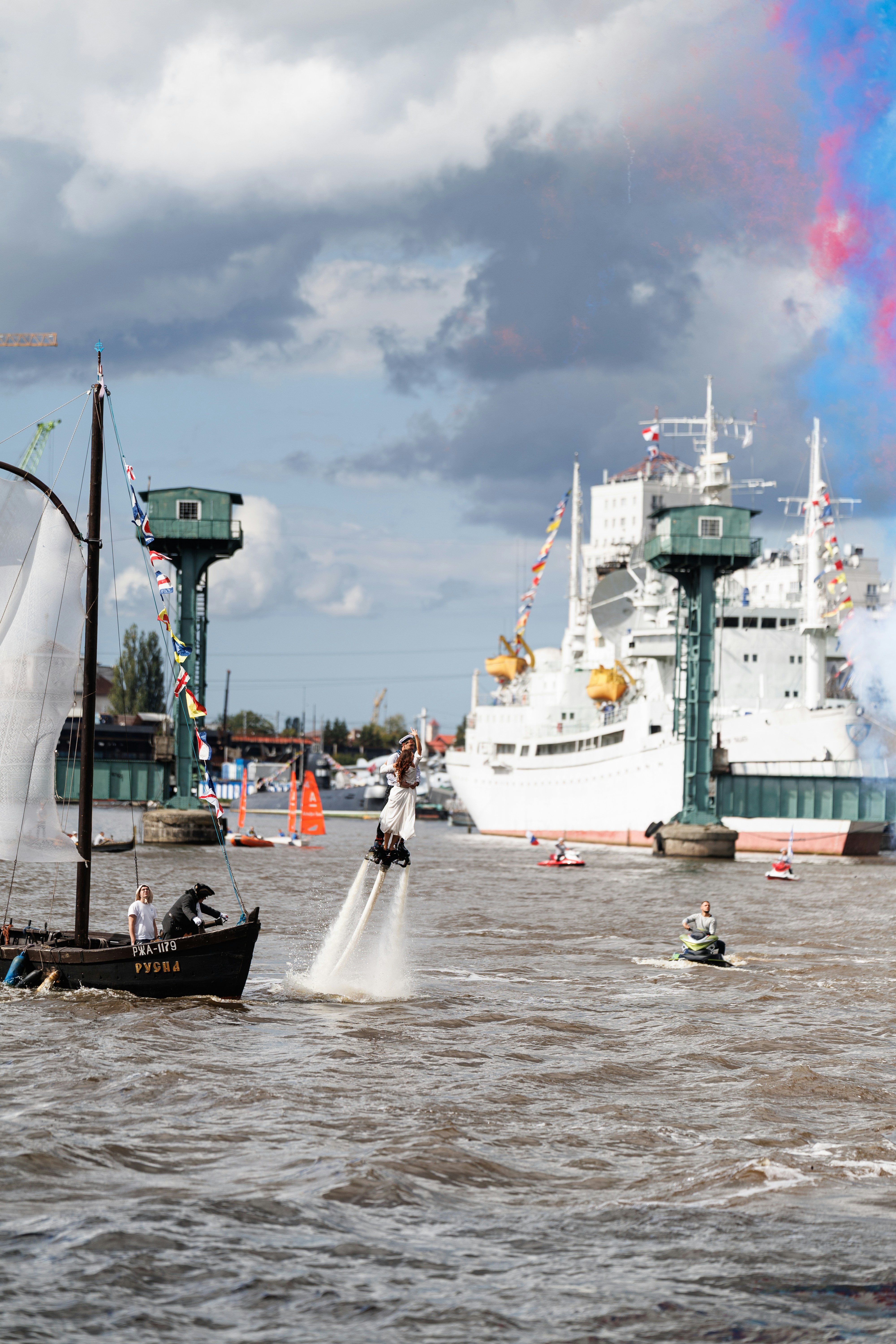 Jetboards and Giants: Maritime Parade on a Murky Afternoon