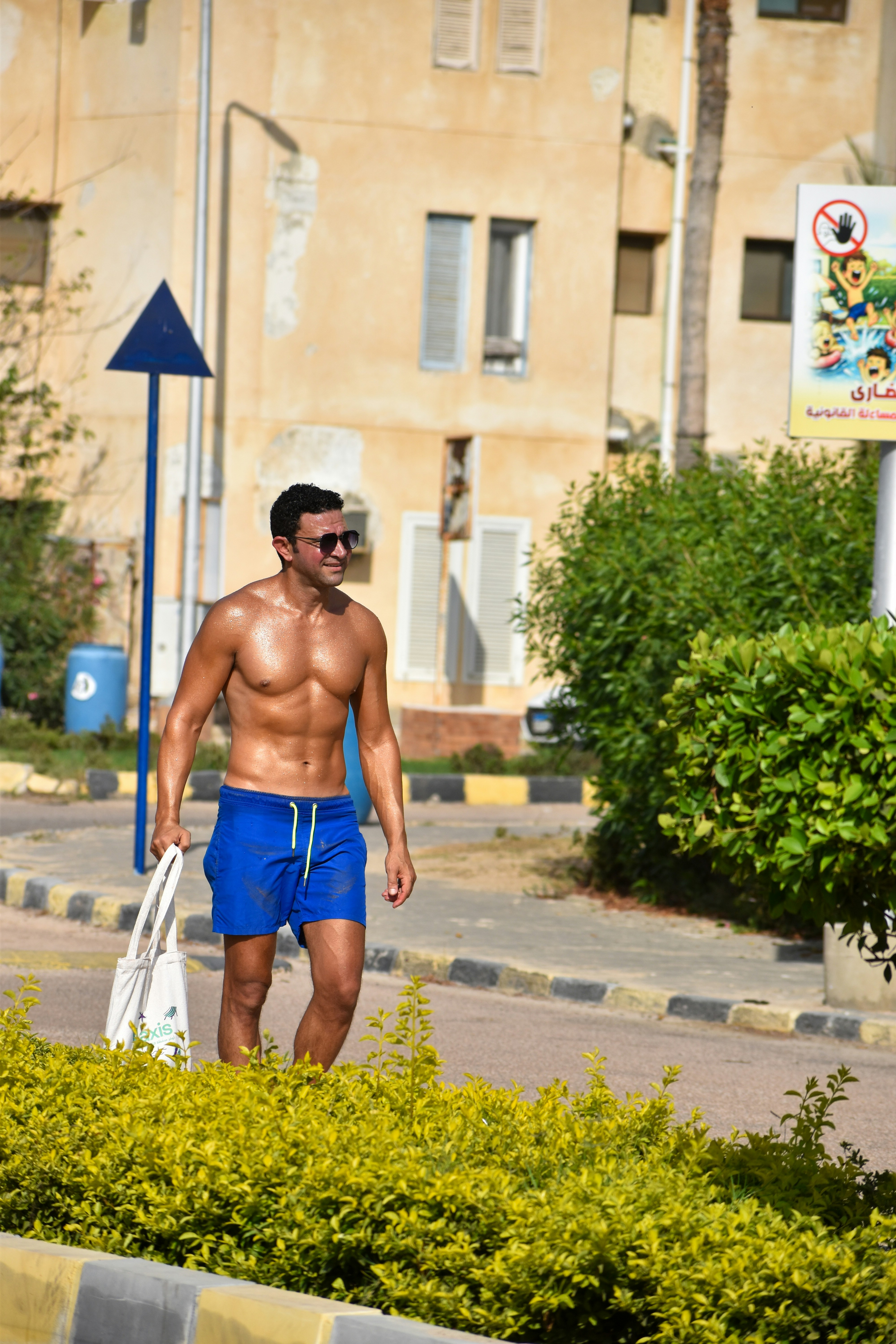 Sunlit Street Gym: A Muscle-Molded Walk Amid Mediterranean Greens
