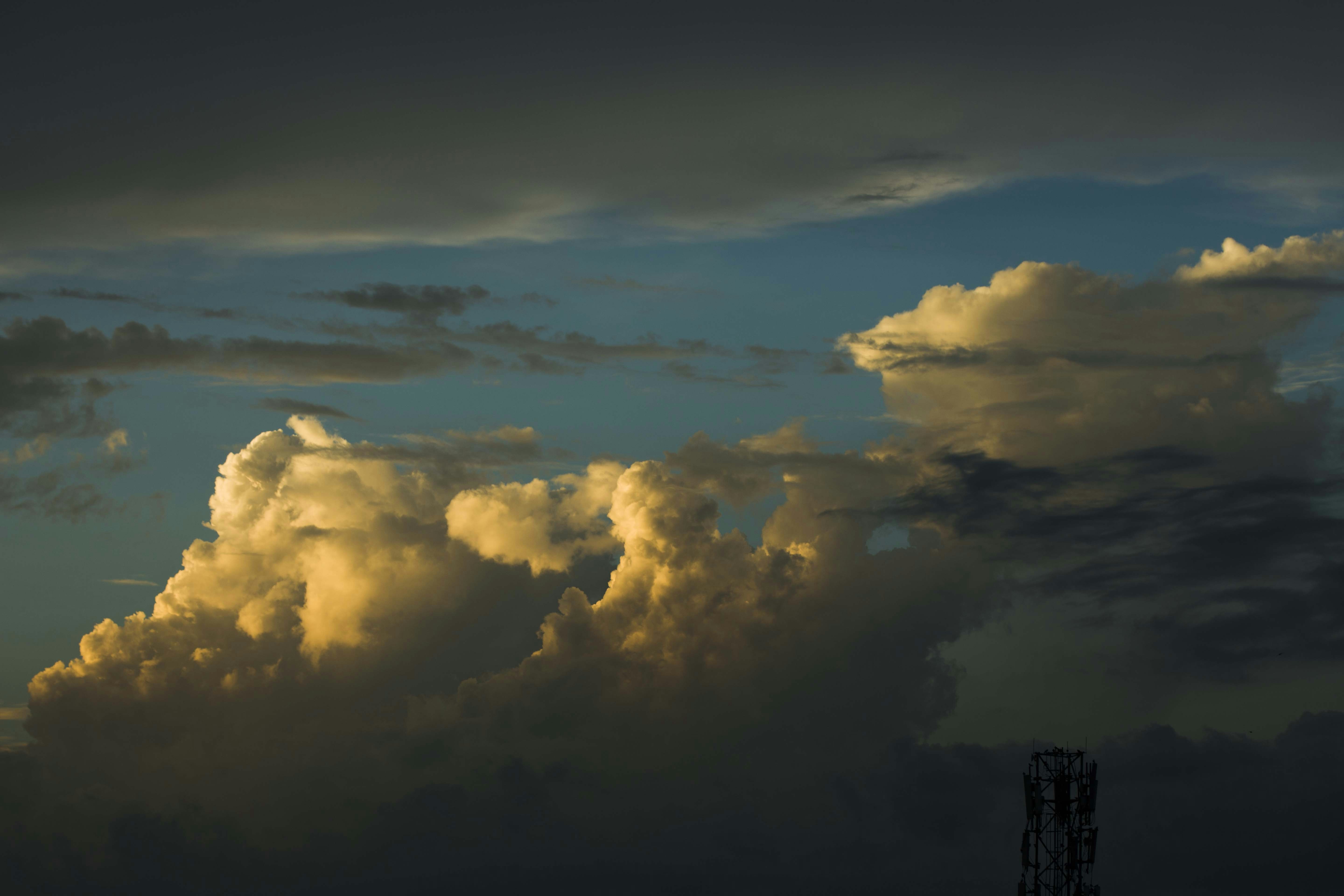 Sunlit Cloud Cathedral over a Quiet Horizon