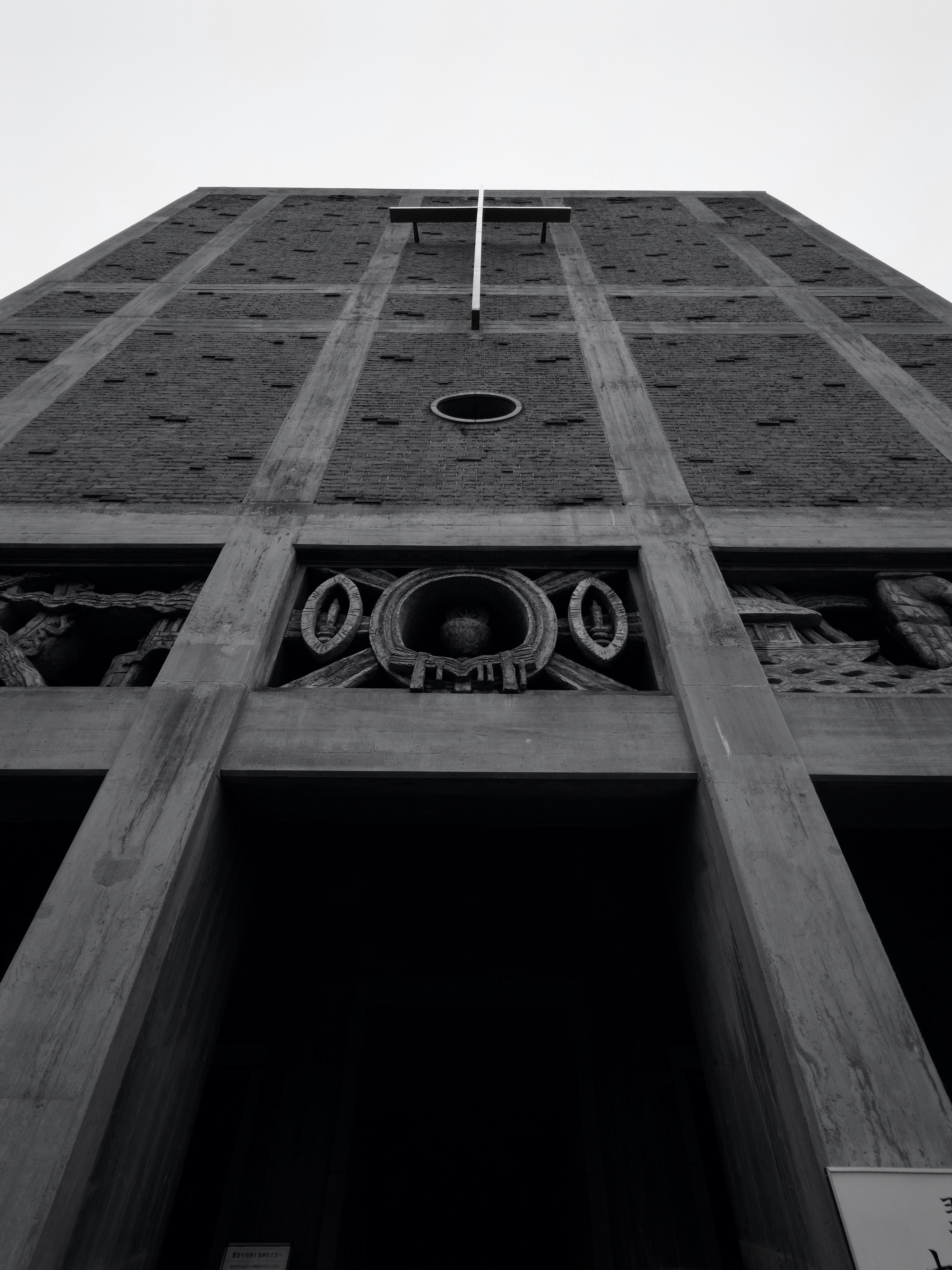 Vertical Ledger: A Monumental Brick Facade Reaching Toward the Sky