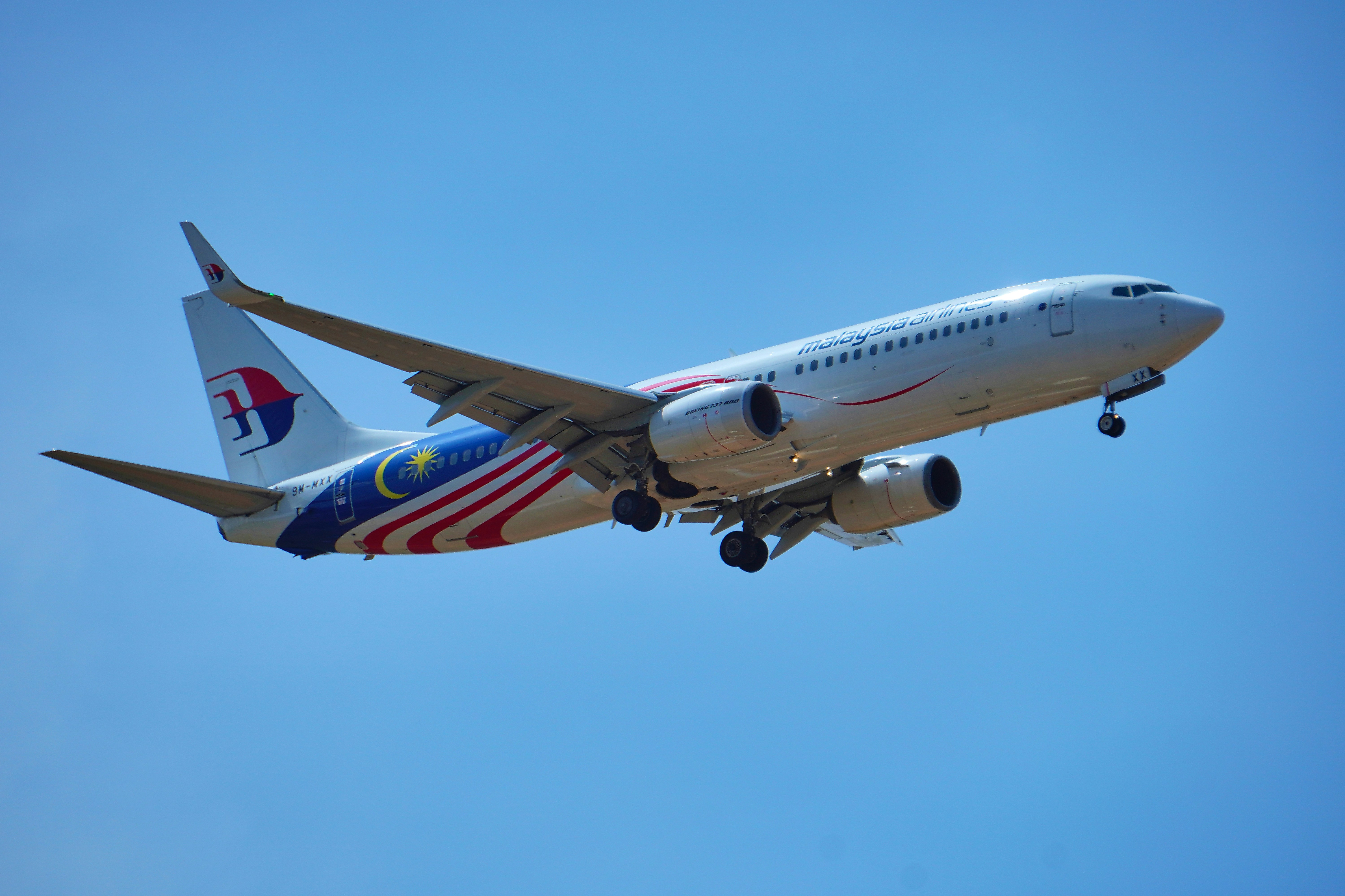 Skyward Banner: A Malaysia Airlines Airbus Ascending under a Clear Blue