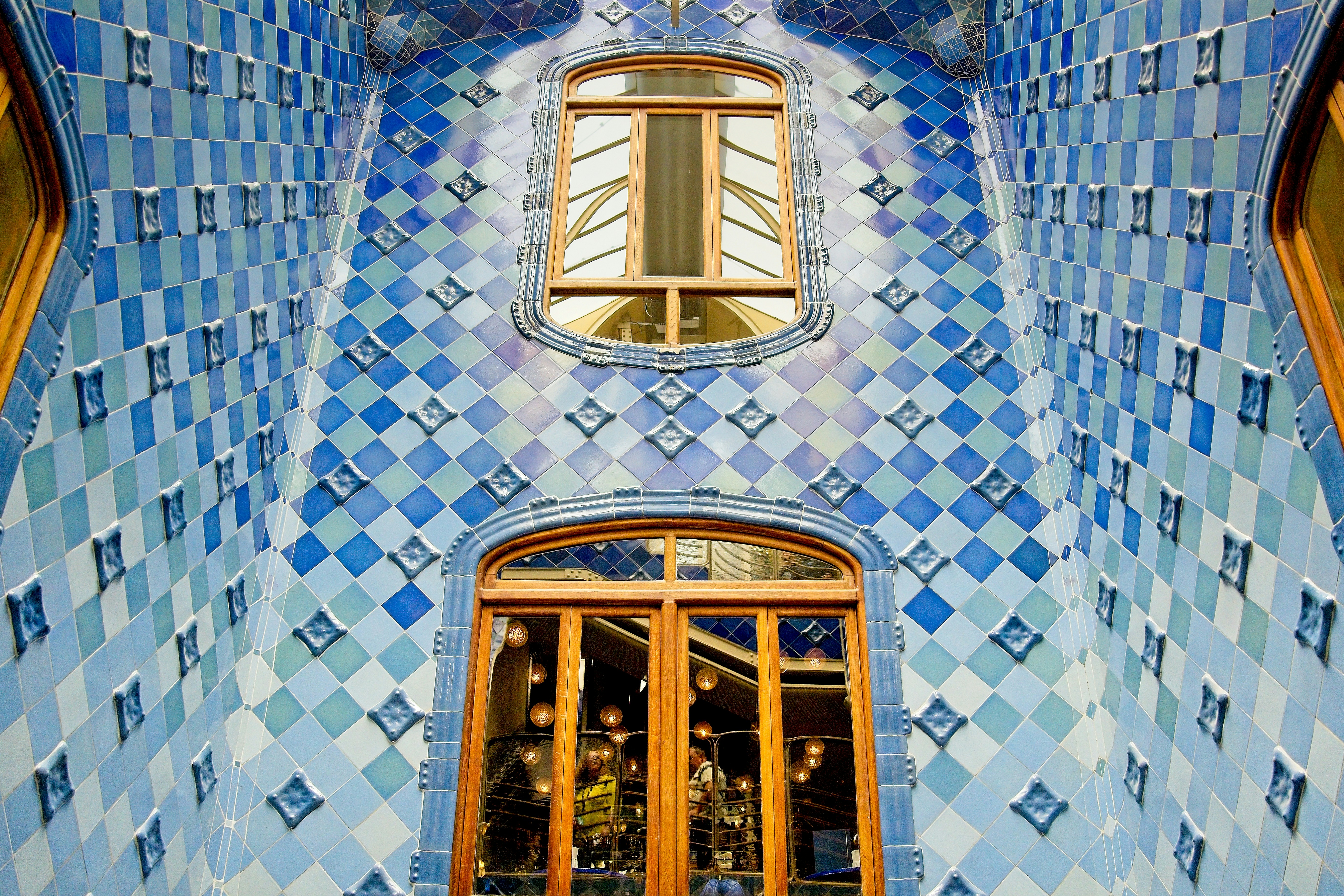 Blue Mosaic Hallway: A Tilted Perspective into a Windowed Interior