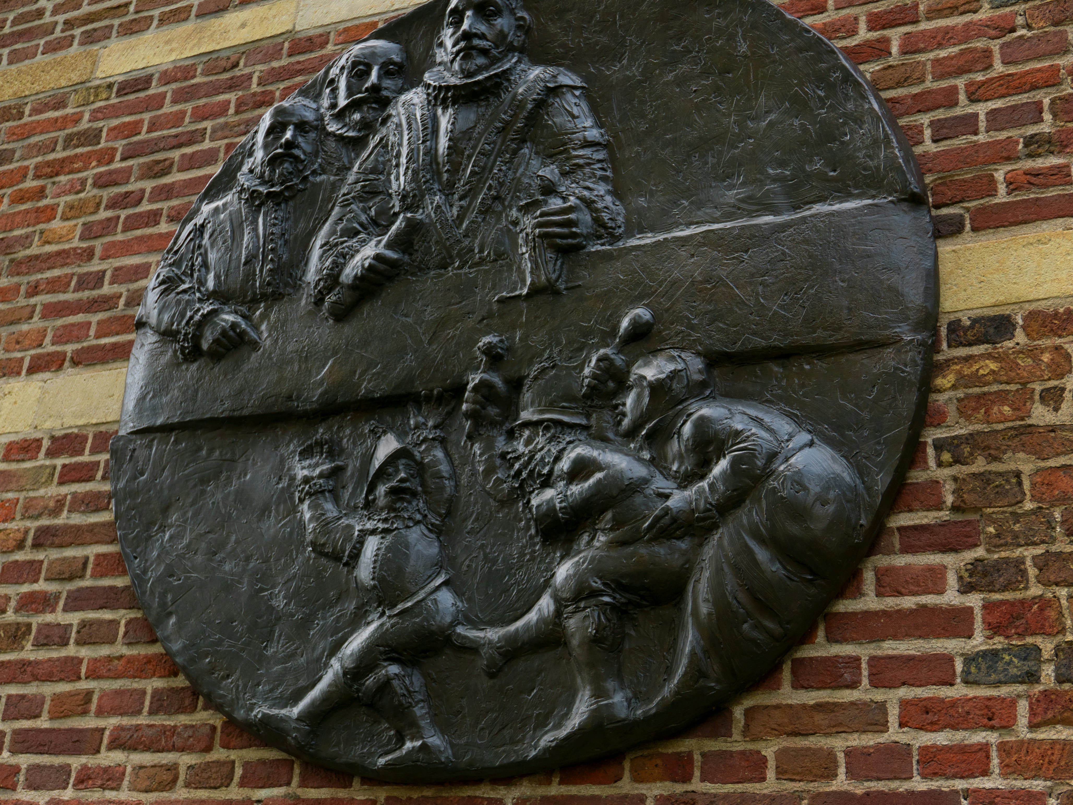 Relief of a Struggle: A Circular Panel Set in Brick