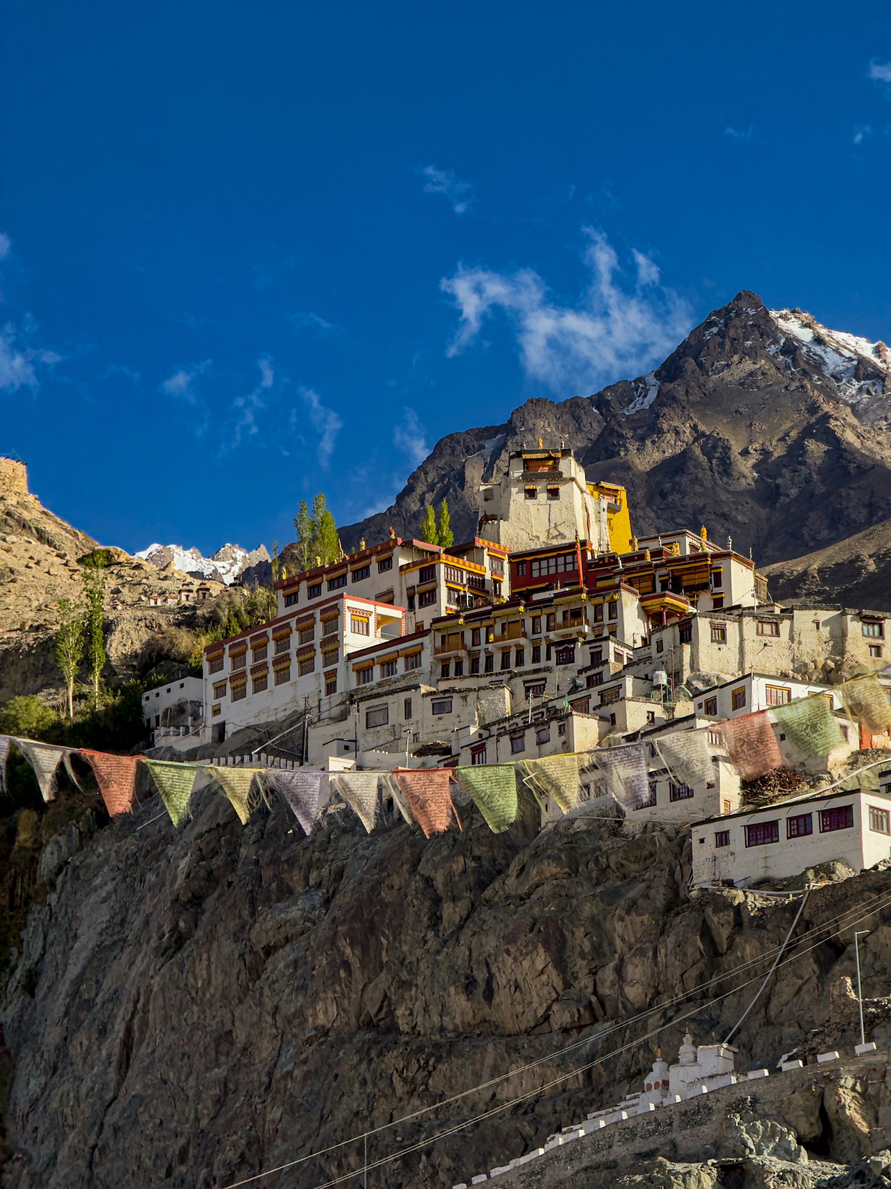 Colorful hillside monastery under a cobalt sky
