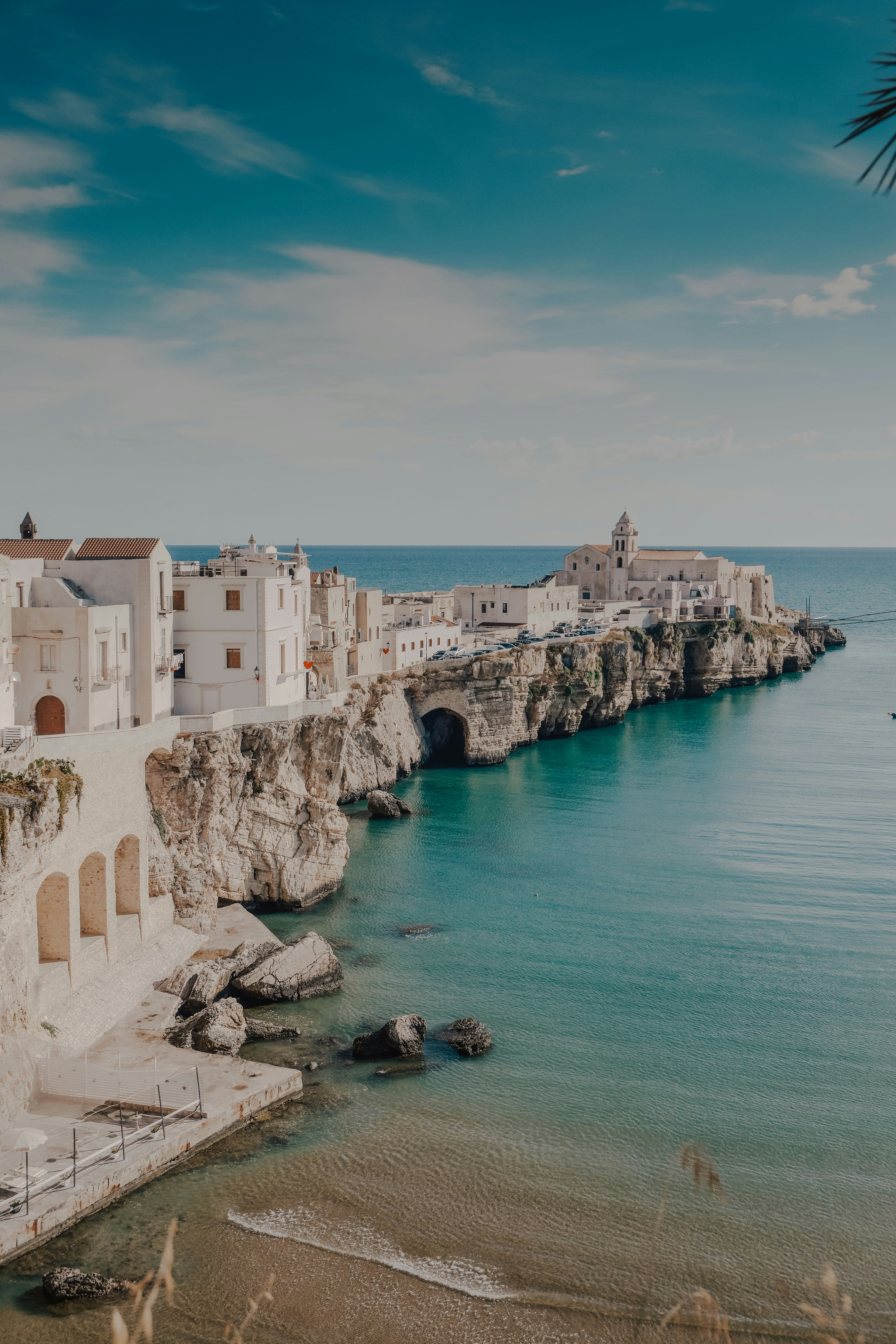 Whitewashed Coastline: Historic Cliffside Streets Meet Turquoise Seas
