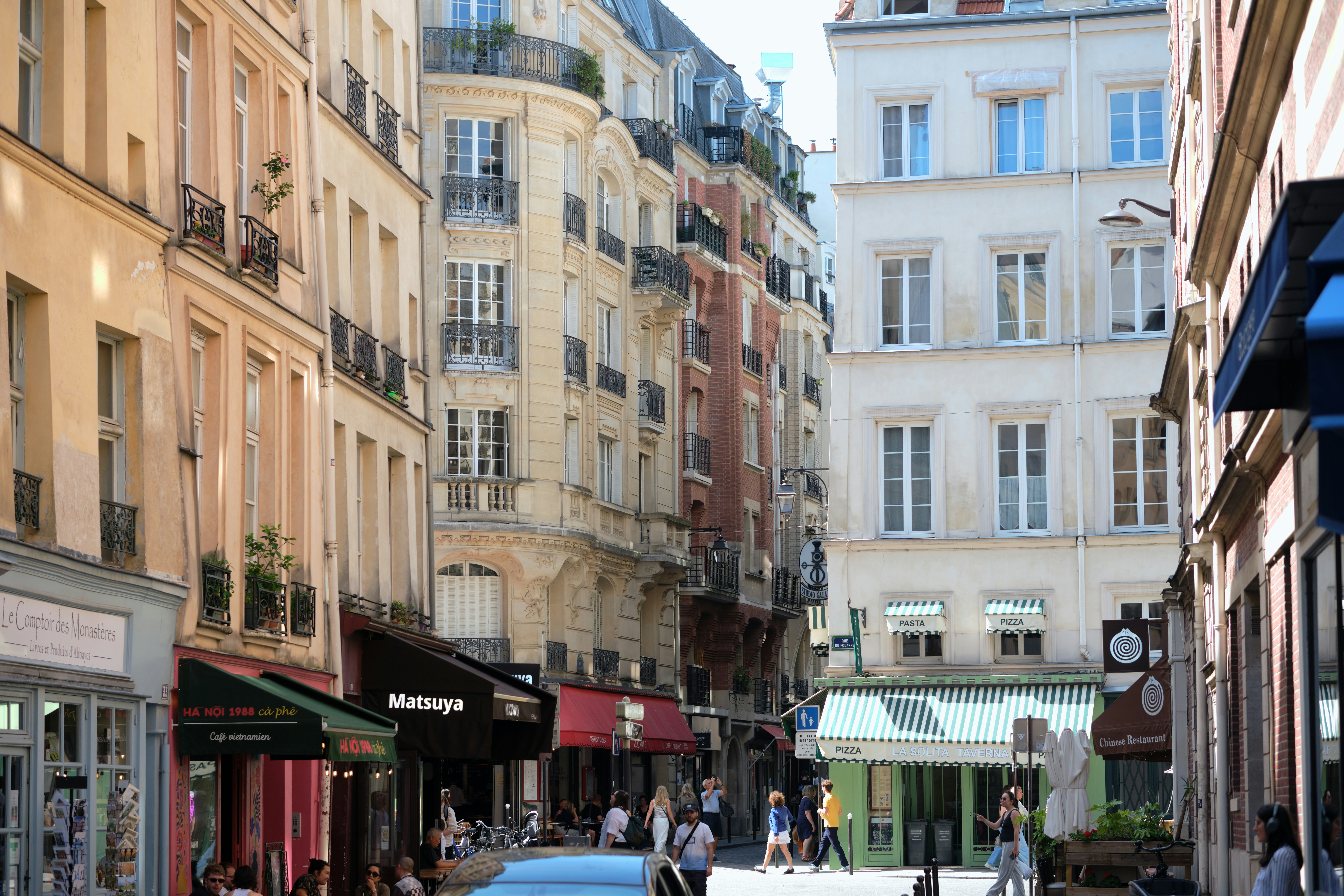 Sunlit Parisian Street Beneath Ornate Facades