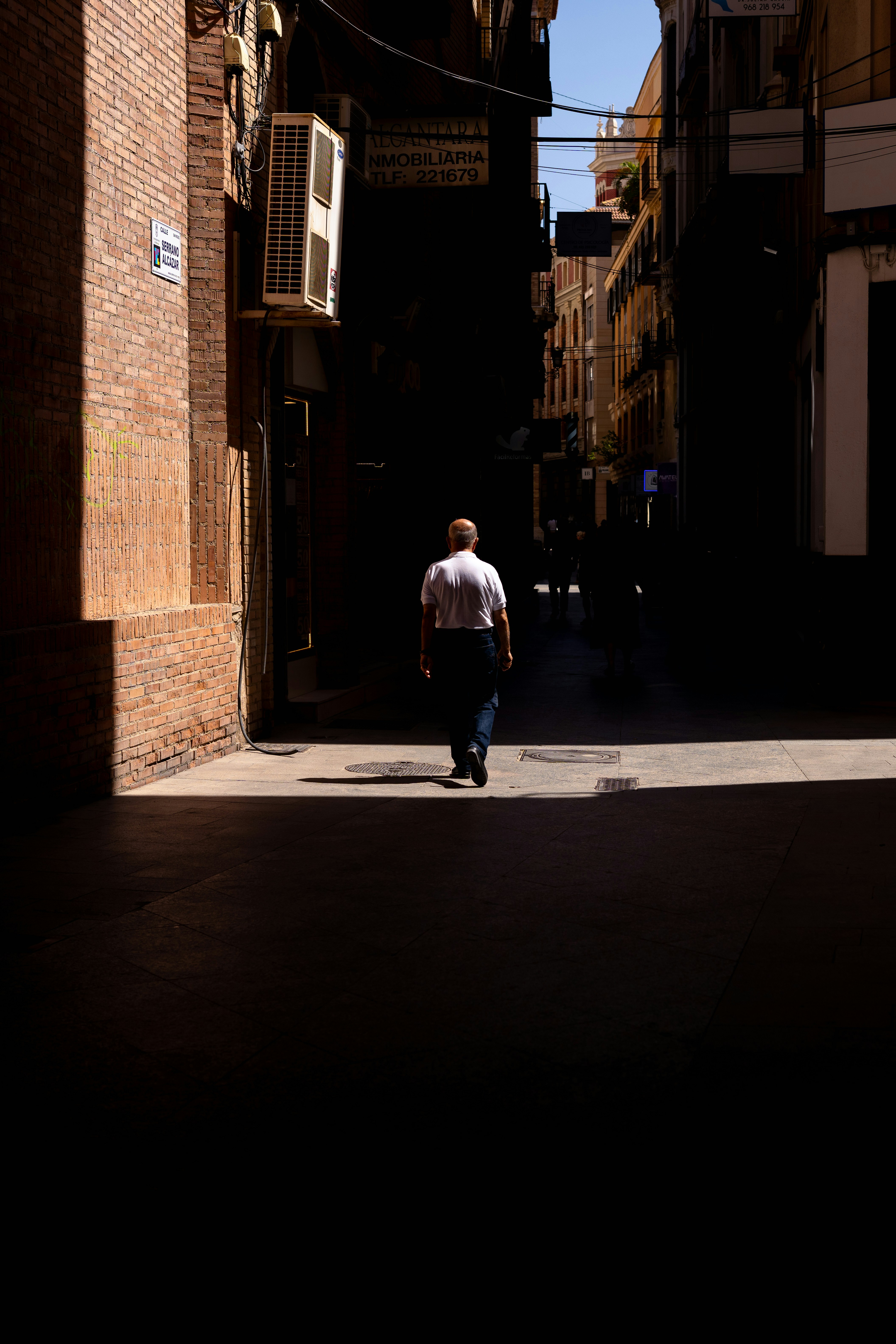 Single Pedestrian in a Sunlit Alleyway
